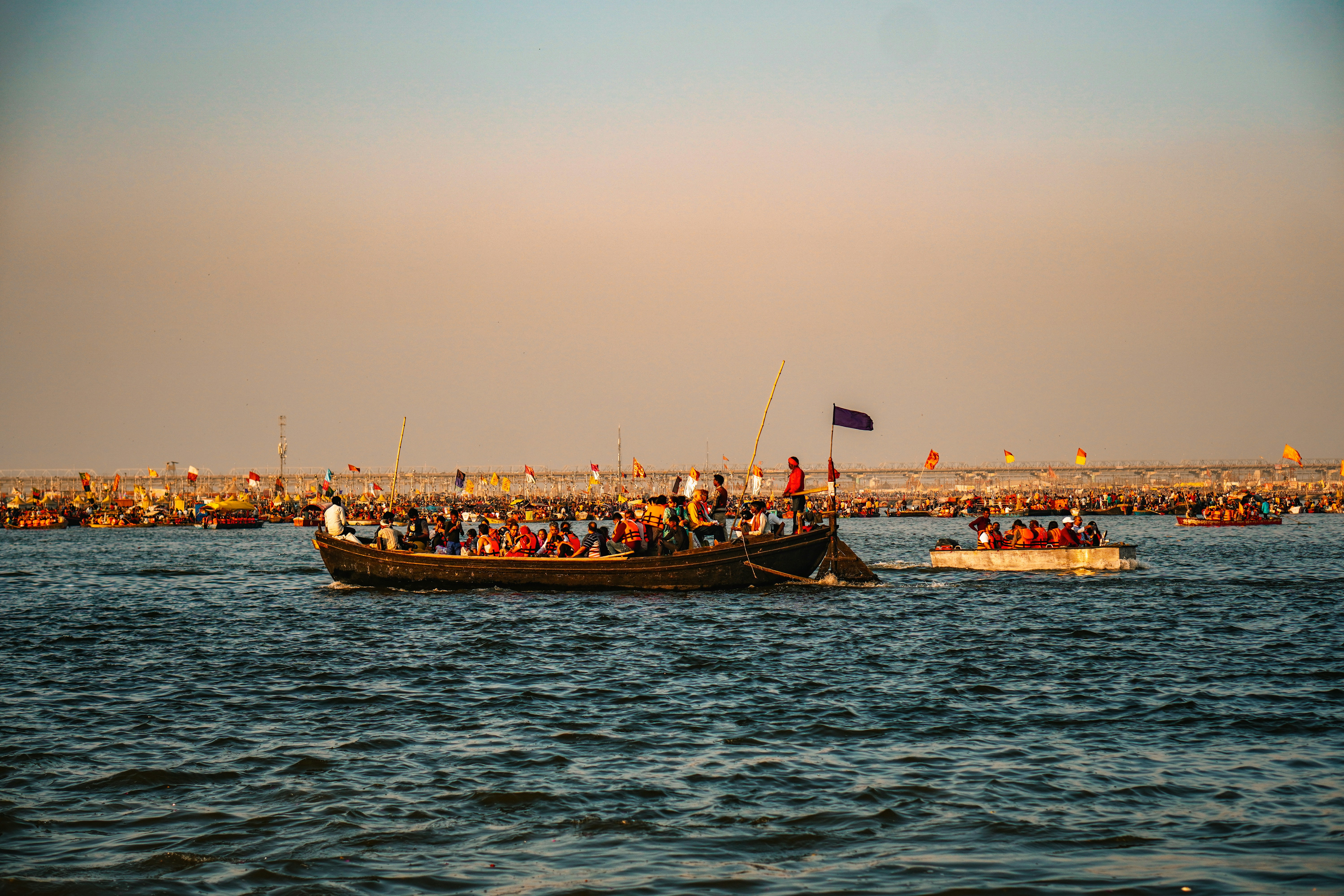 Harbor Parade: A Crowded Longboat Traverses a Sunlit Channel