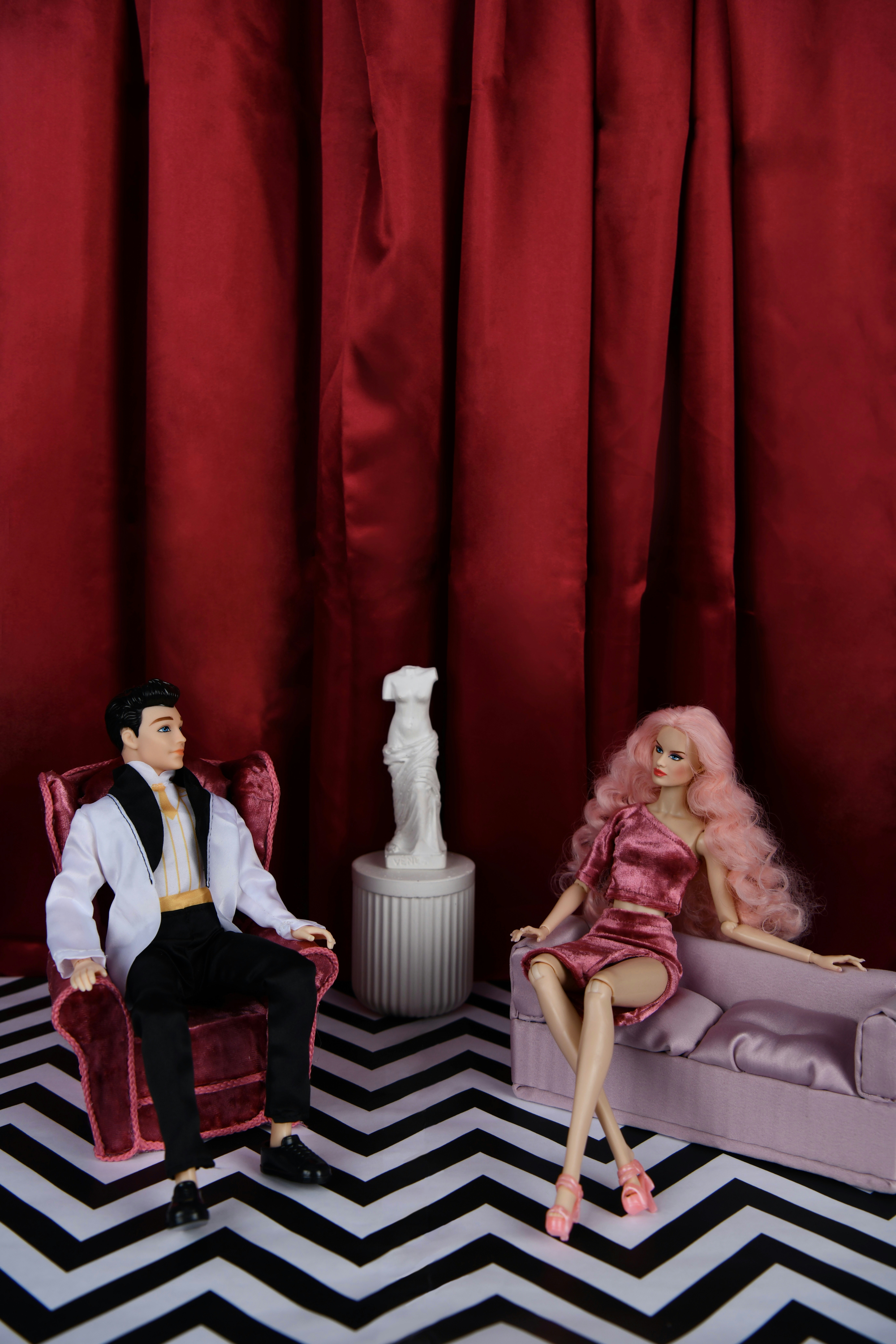 Dolls lounge stylishly in a room with a red curtain. photo – Free Girl ...