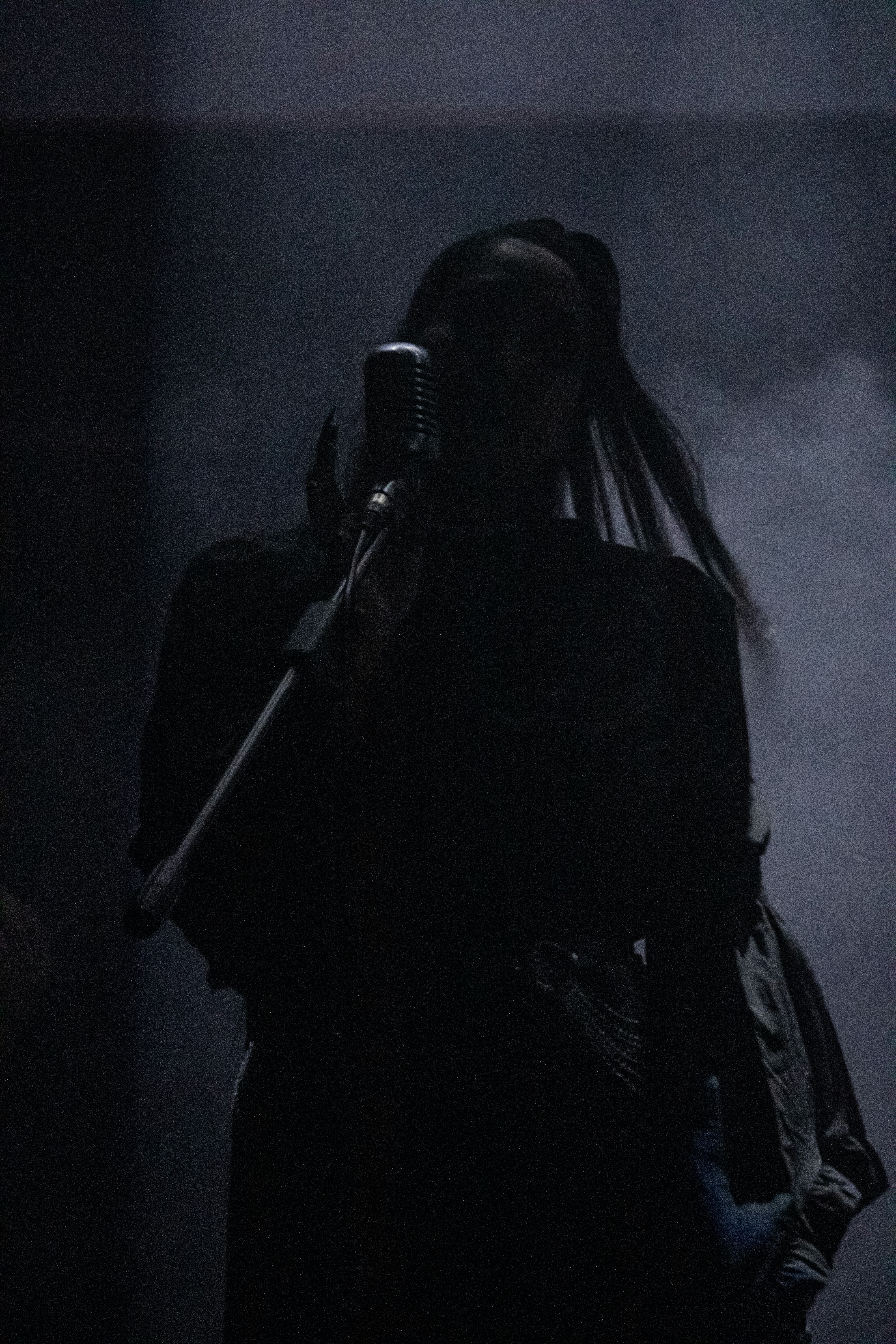 Singer performs into a vintage microphone in darkness. photo – Free ...