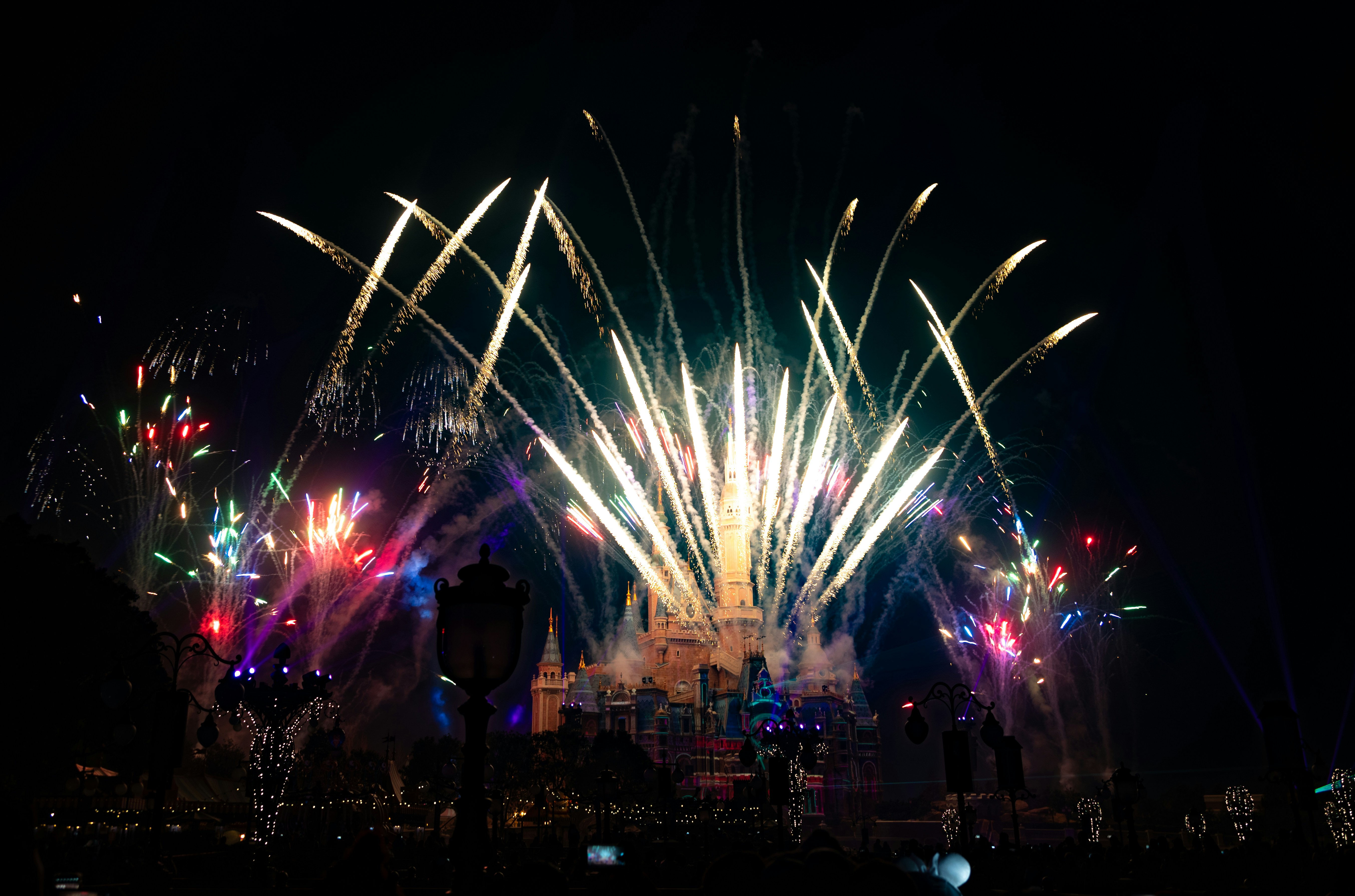 Fireworks explode over a disney castle at night. photo – Free China ...