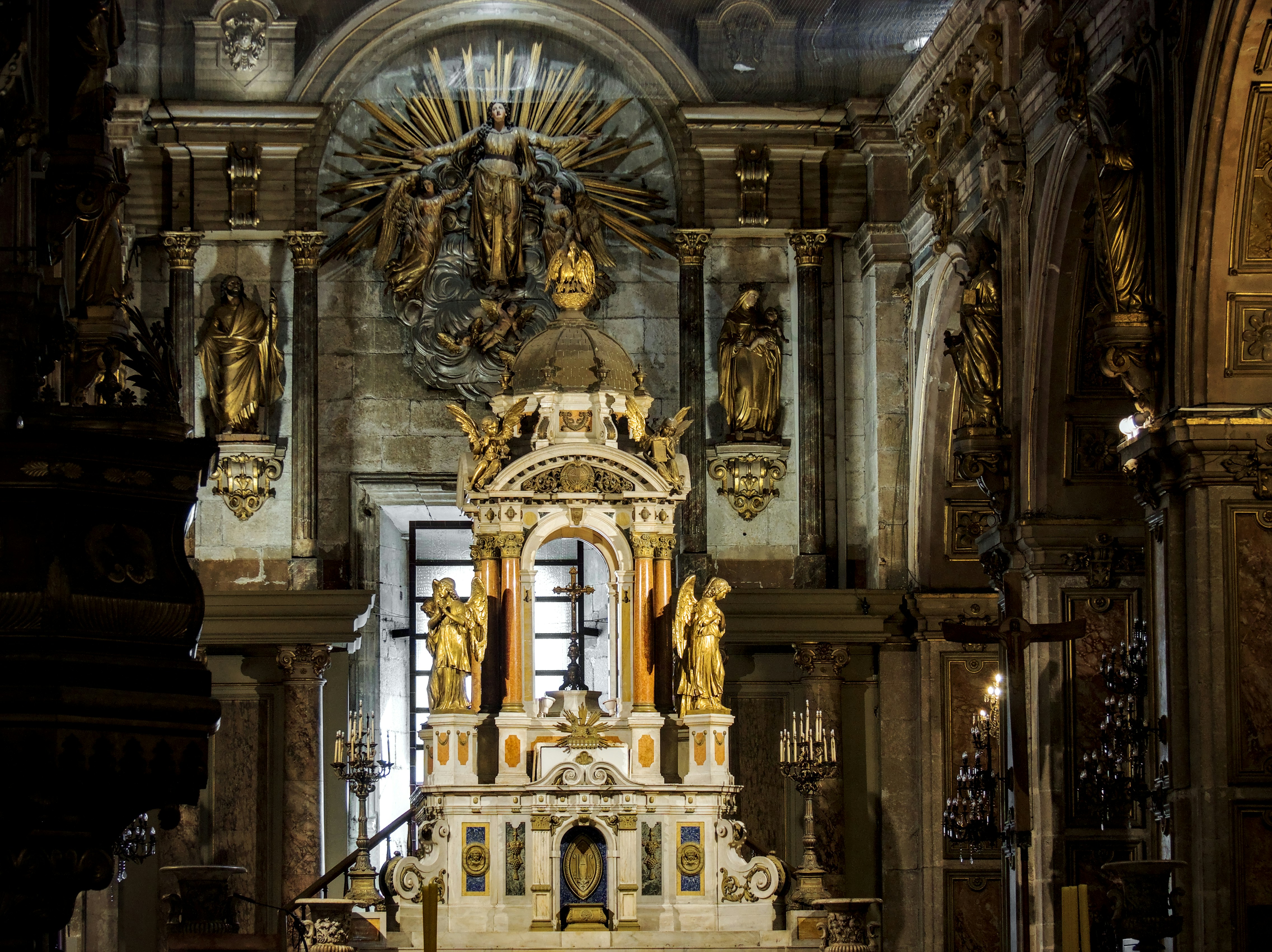 Ornate church altar adorned with golden statues and intricate architectural details.