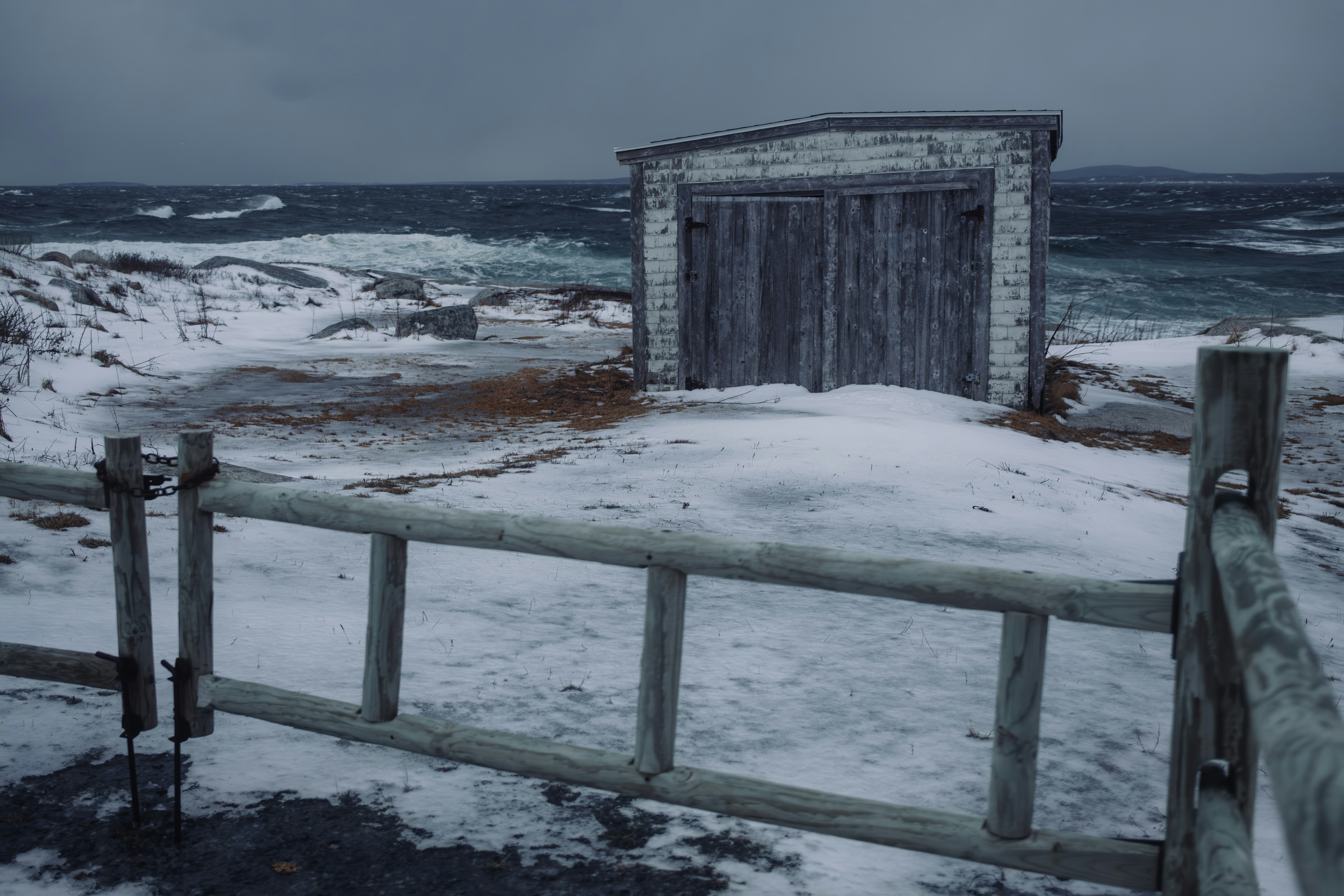 A small shack sits on a snowy shoreline. photo – Free House Image on ...