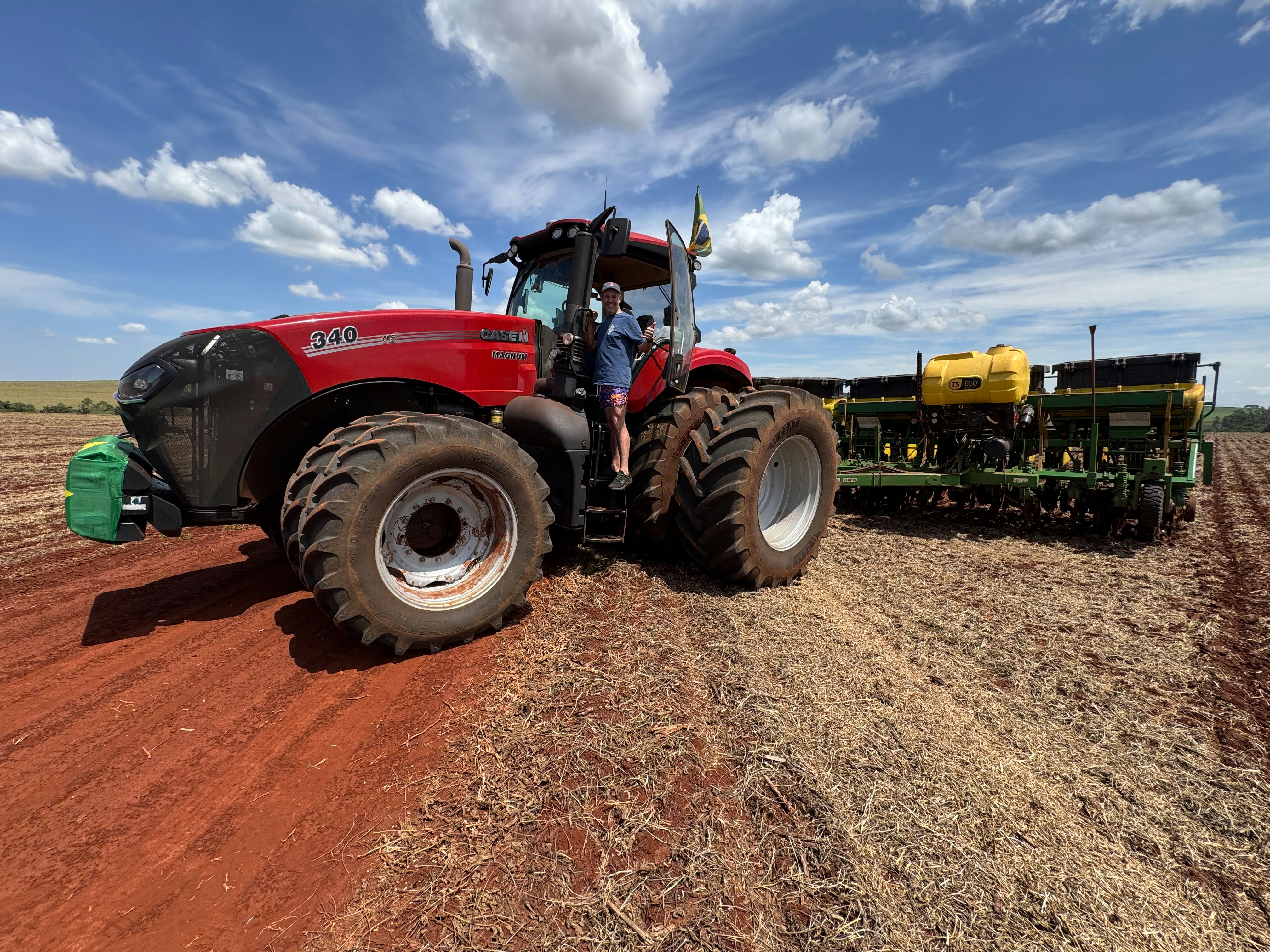 Red Power Through Red Earth: Tractor and Planter Carve a Path Across the Field