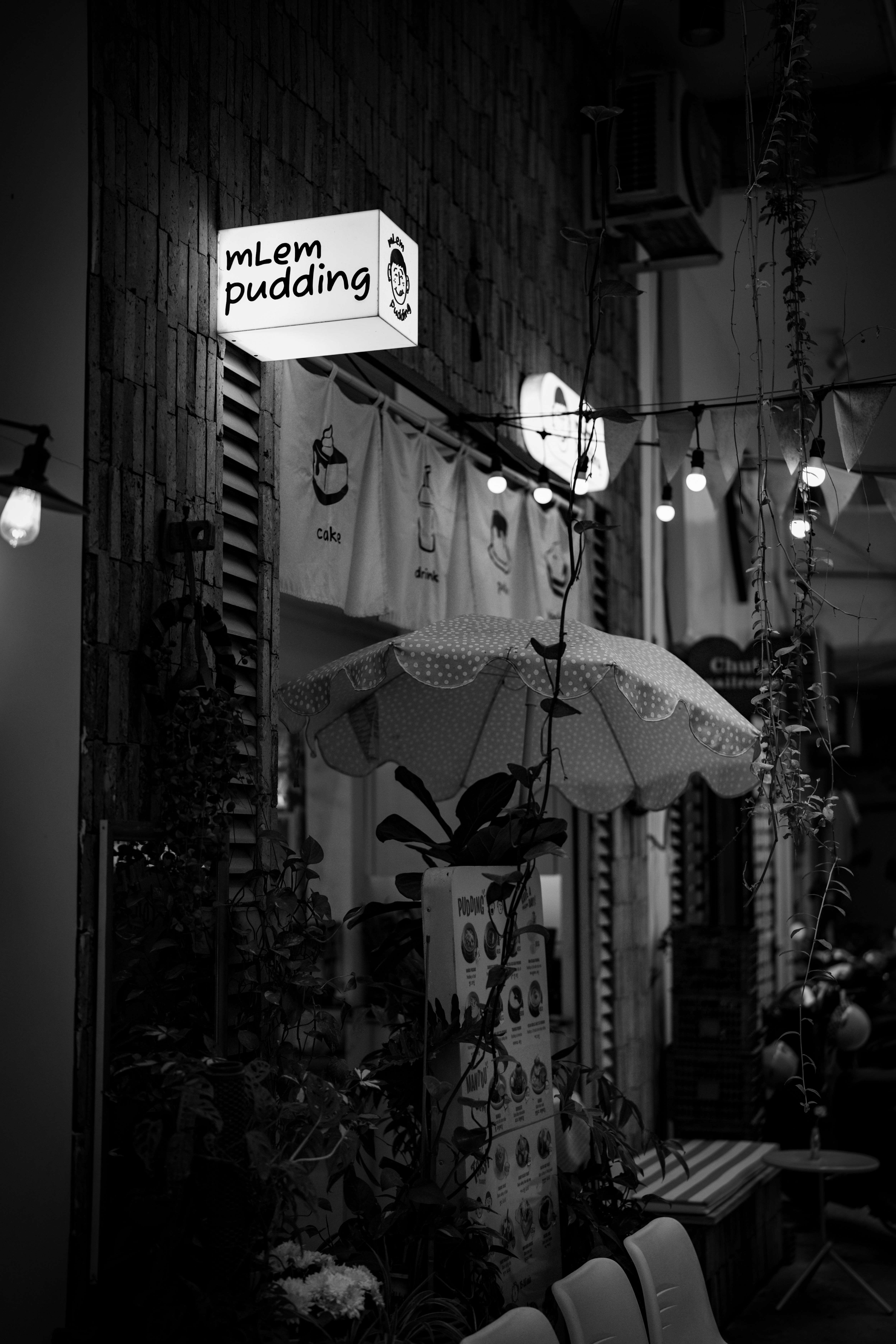 A quaint dessert shop sign is illuminated. photo – Free City Image on ...