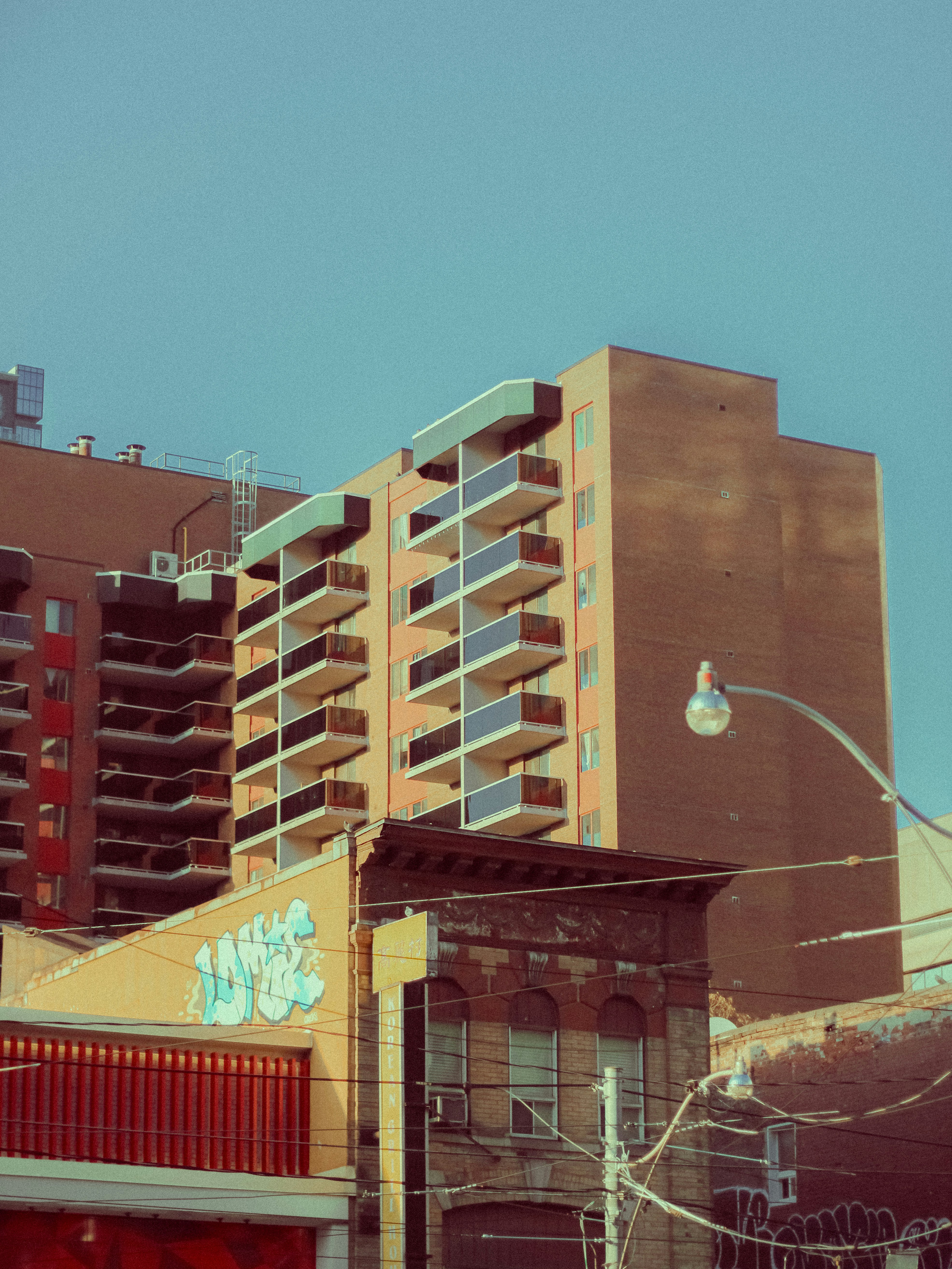 Cantilevered Balconies Cast in Pale Azure: An Urban Geometry Portrait