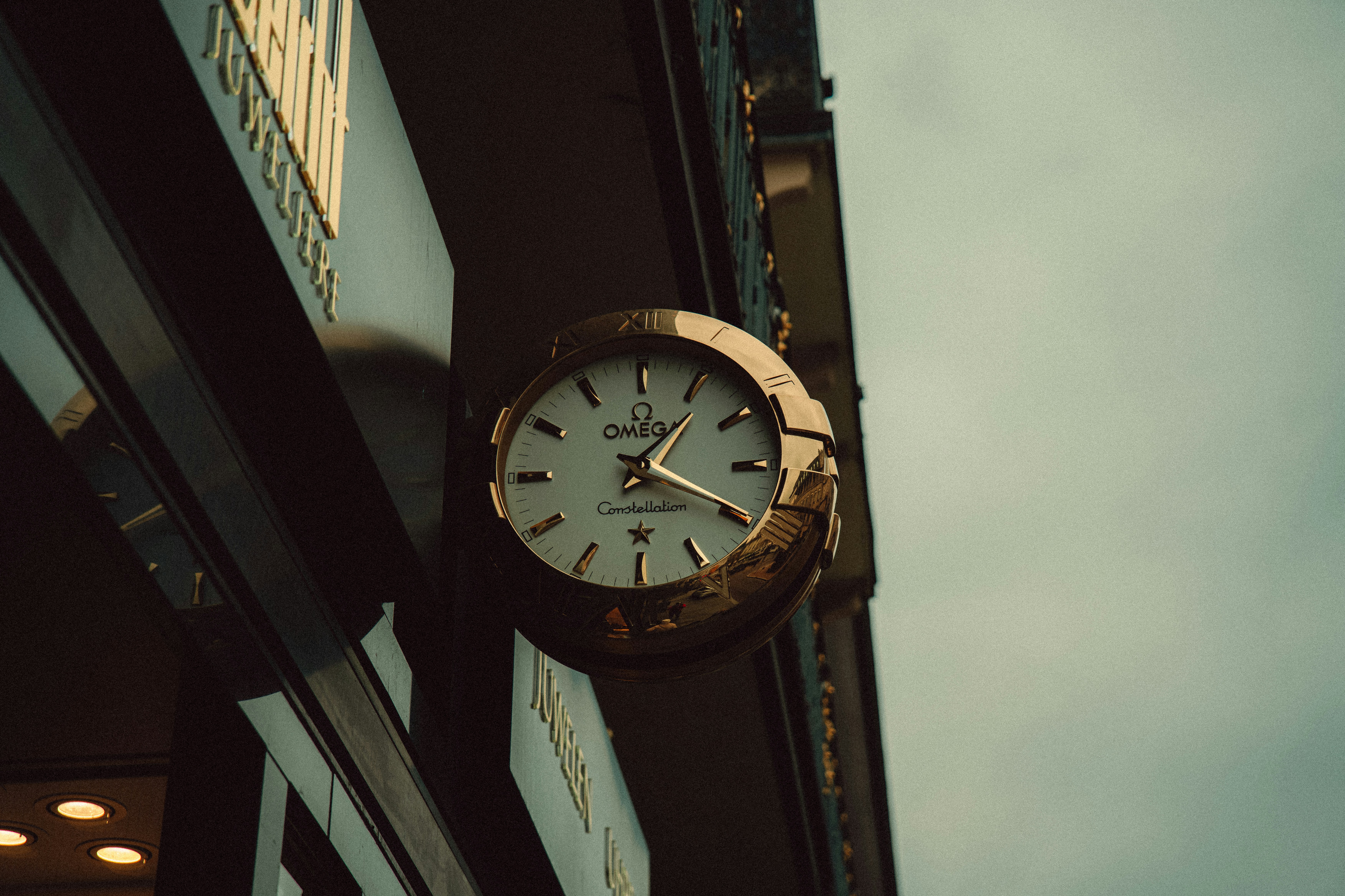 An ornate clock hangs on a building's exterior. photo – Free Clock ...