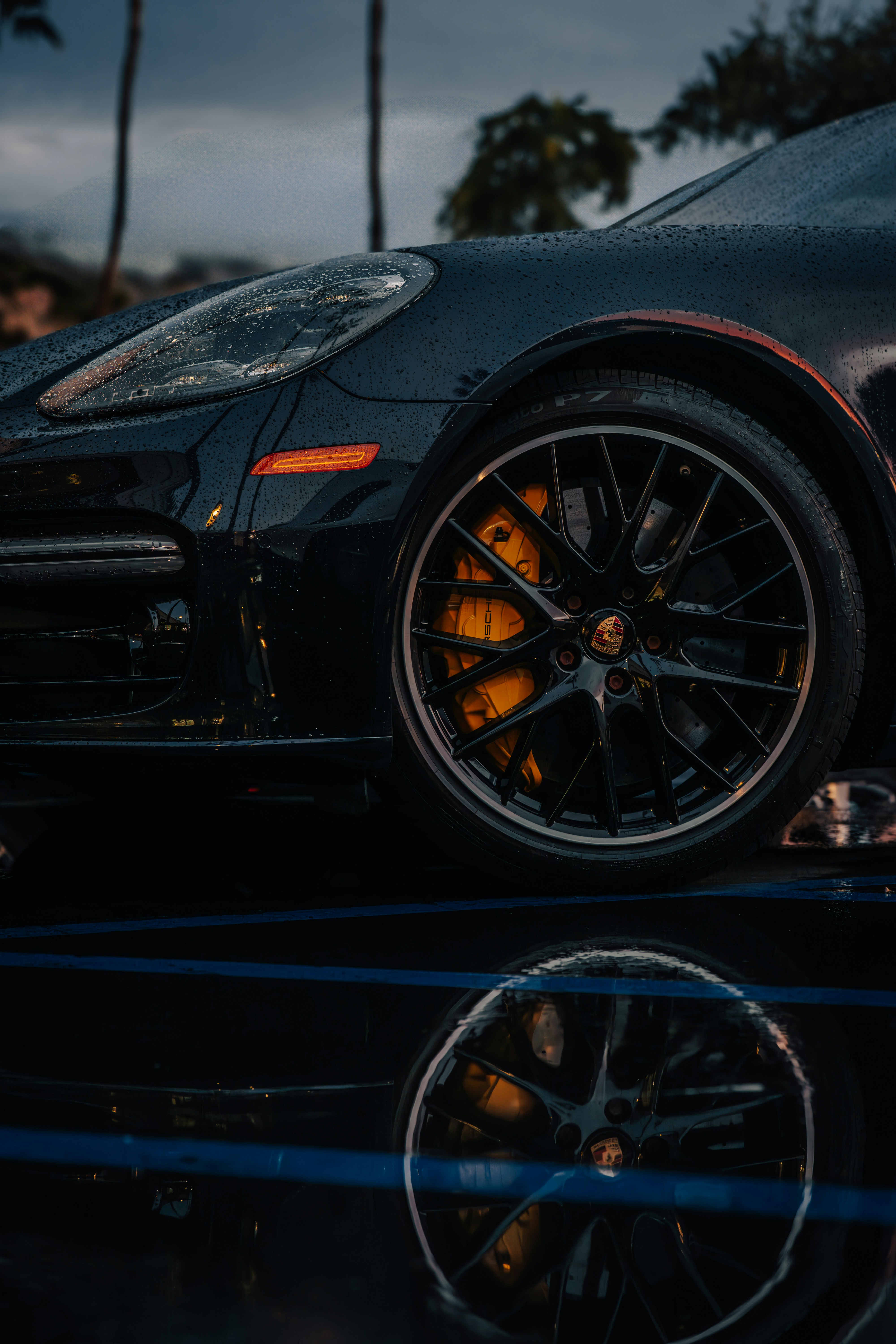 A wet porsche reflected on a damp surface. photo – Free Car Image on ...
