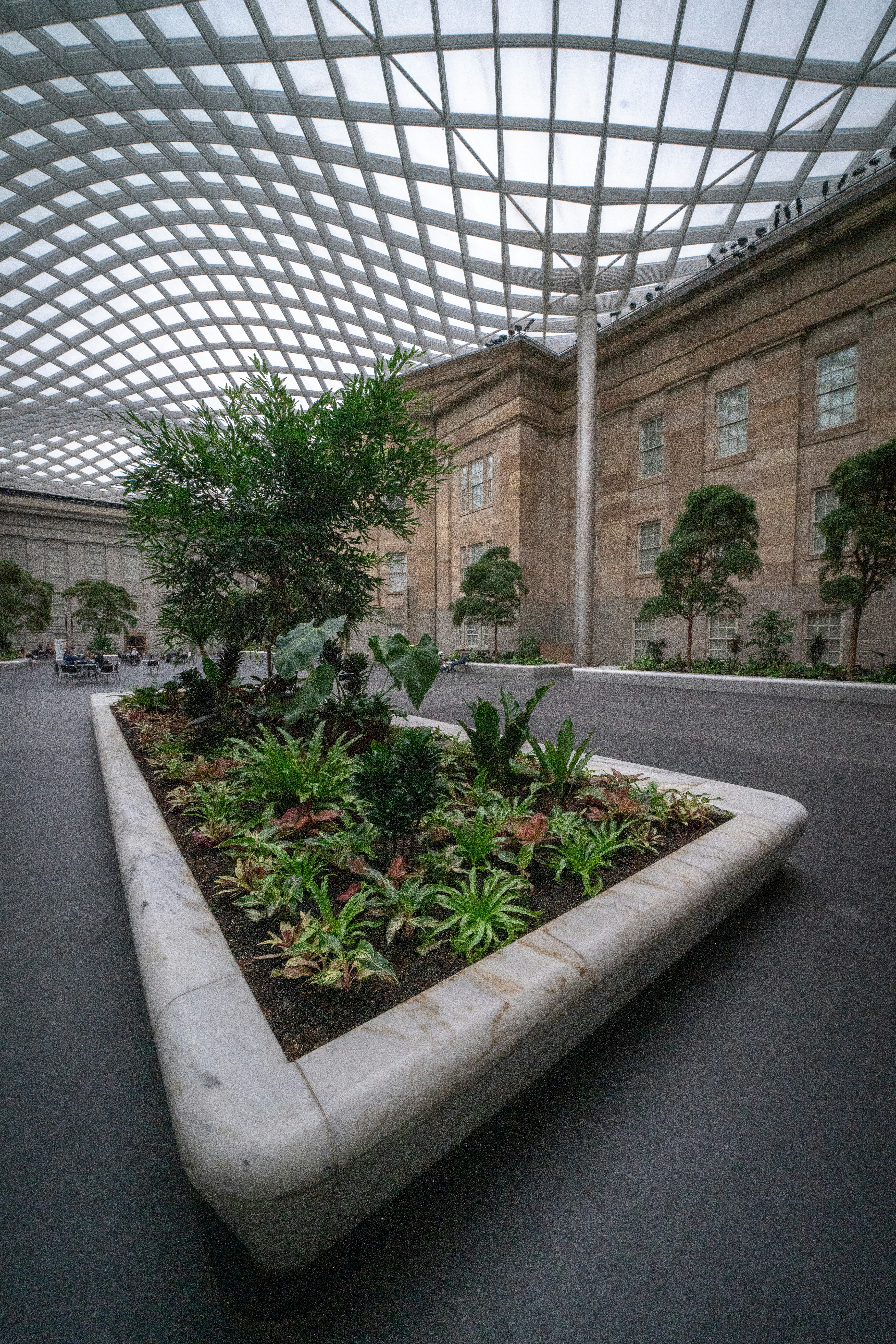 Marble Planter under Glass: A Soothing Indoor Garden in a Grand Atrium
