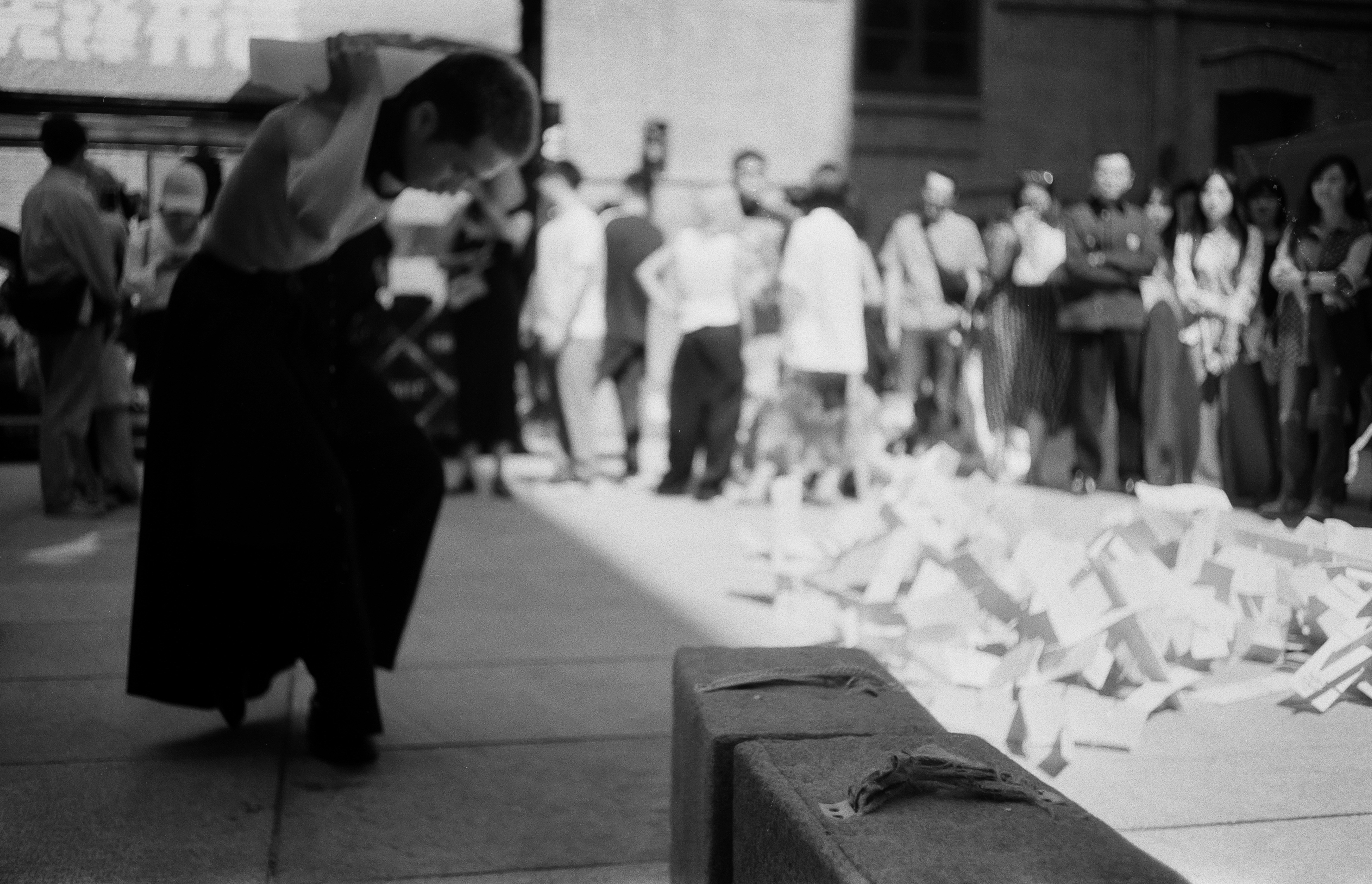 Man bows down, paper spread on the ground. photo – Free Woman Image on ...
