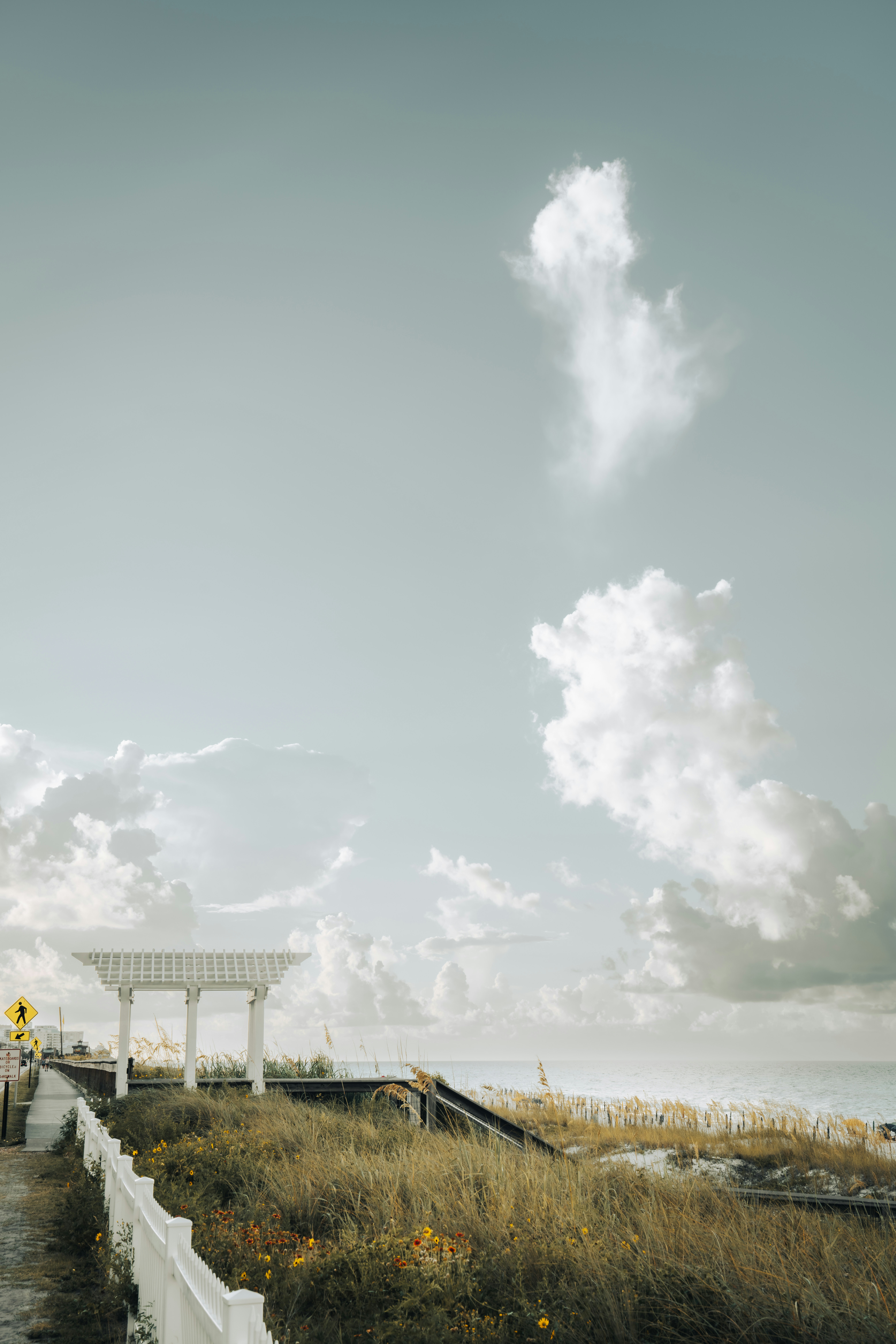 A beach scene features clouds and a white arbor. photo – Free Cloud ...
