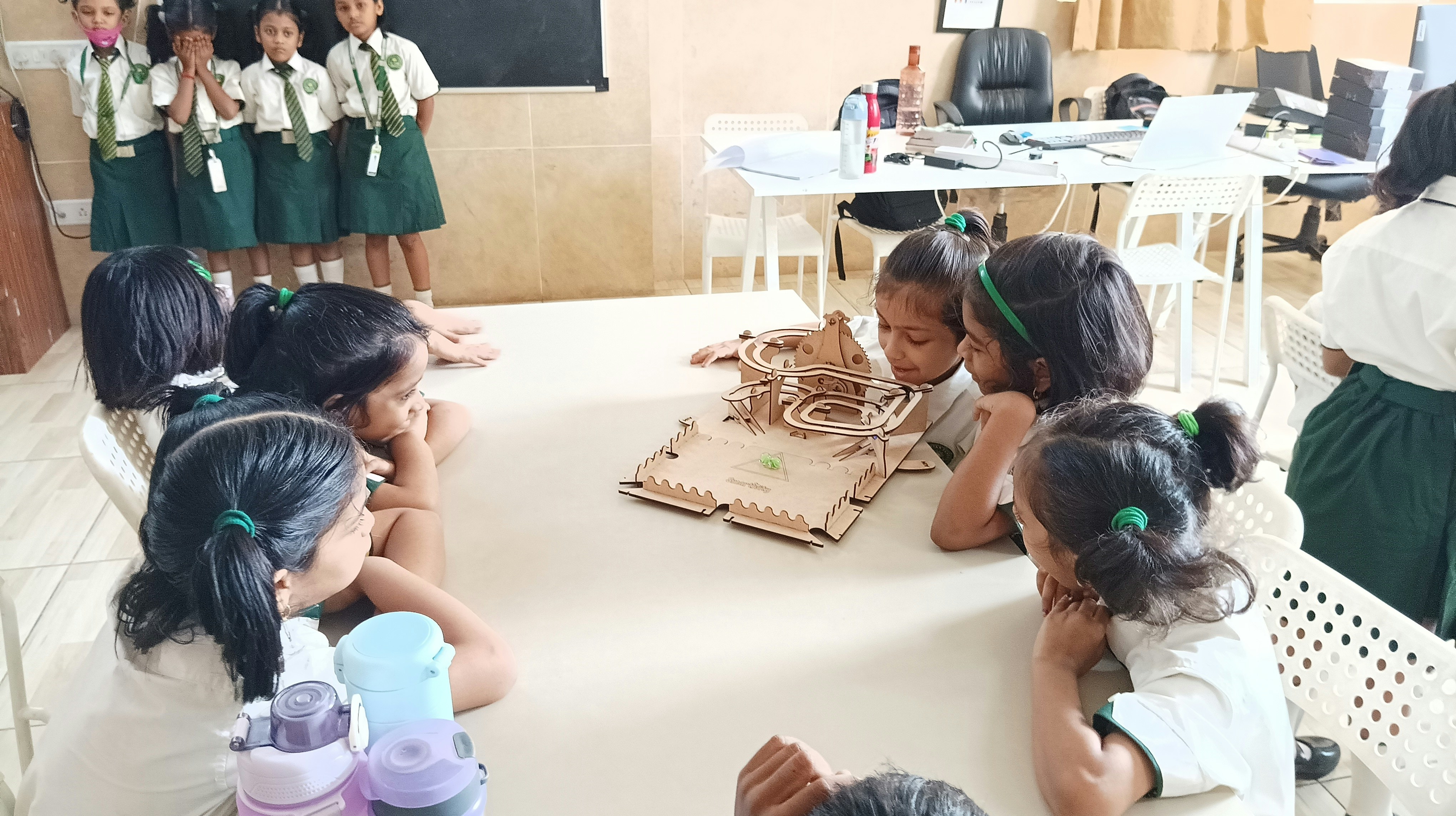 Children admire a model displayed on a table. photo – Free Steam Image ...