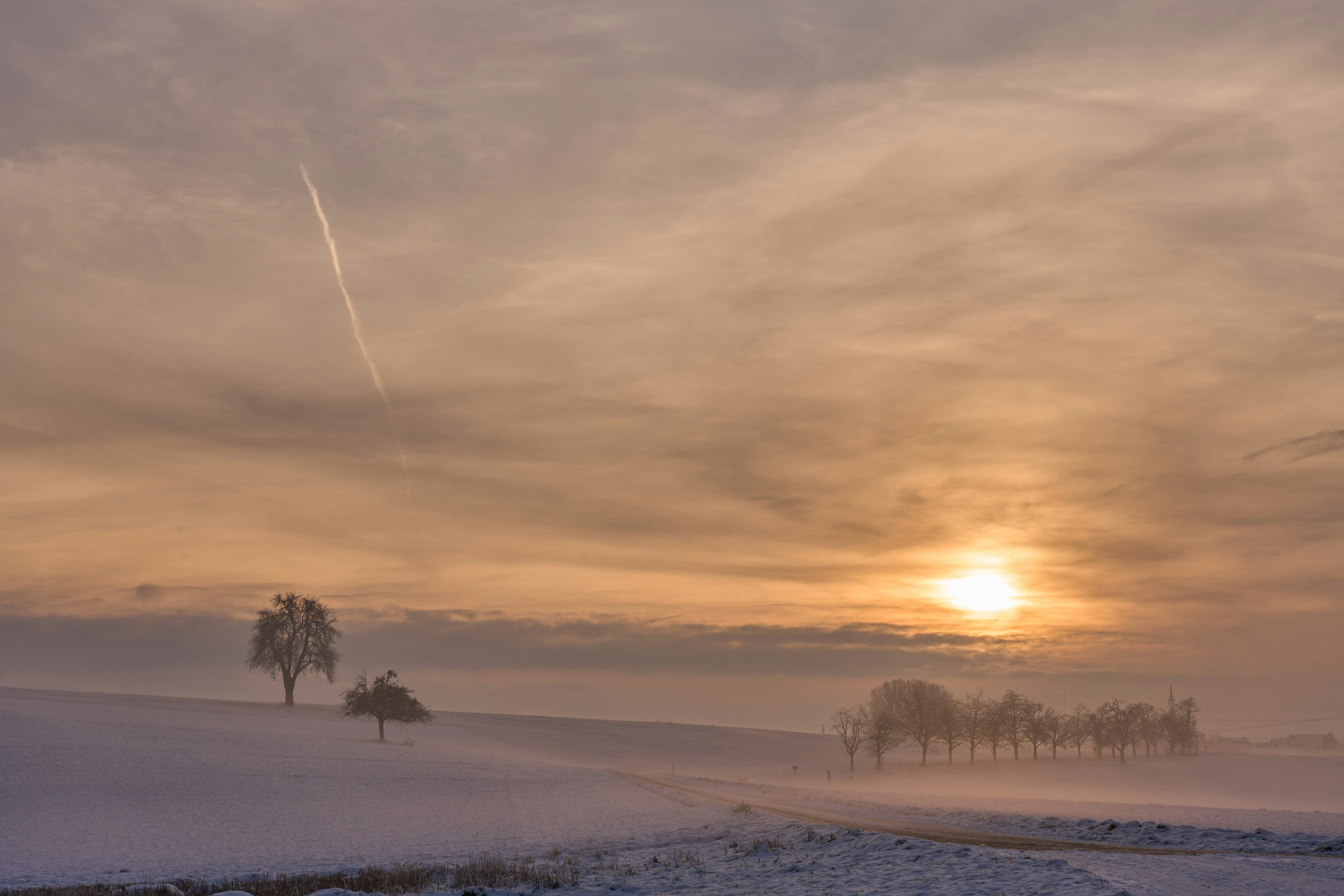 Snowy landscape with sun peeking through the clouds. photo – Free ...