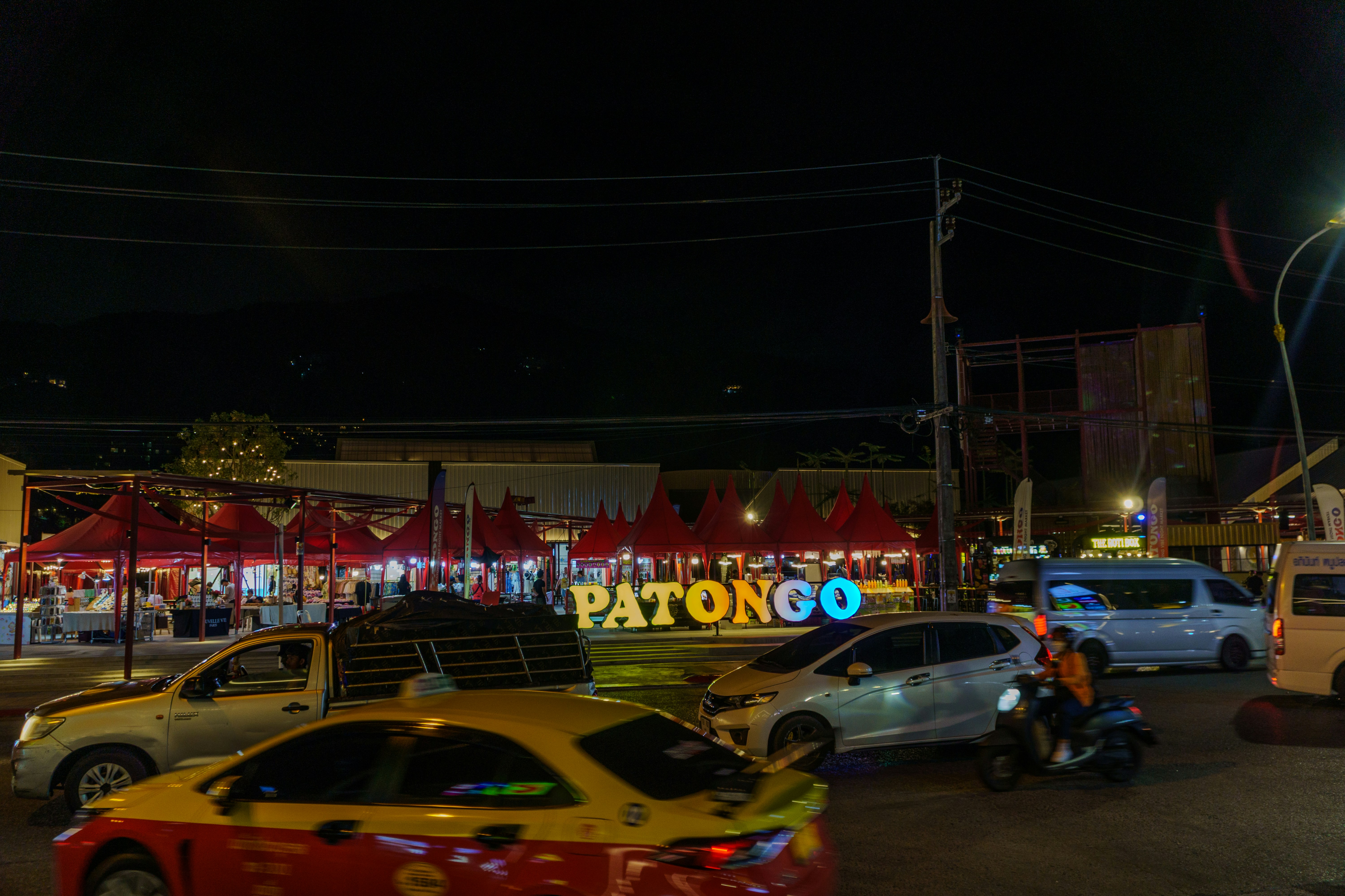 Patongo sign at night with cars. photo – Free Car Image on Unsplash