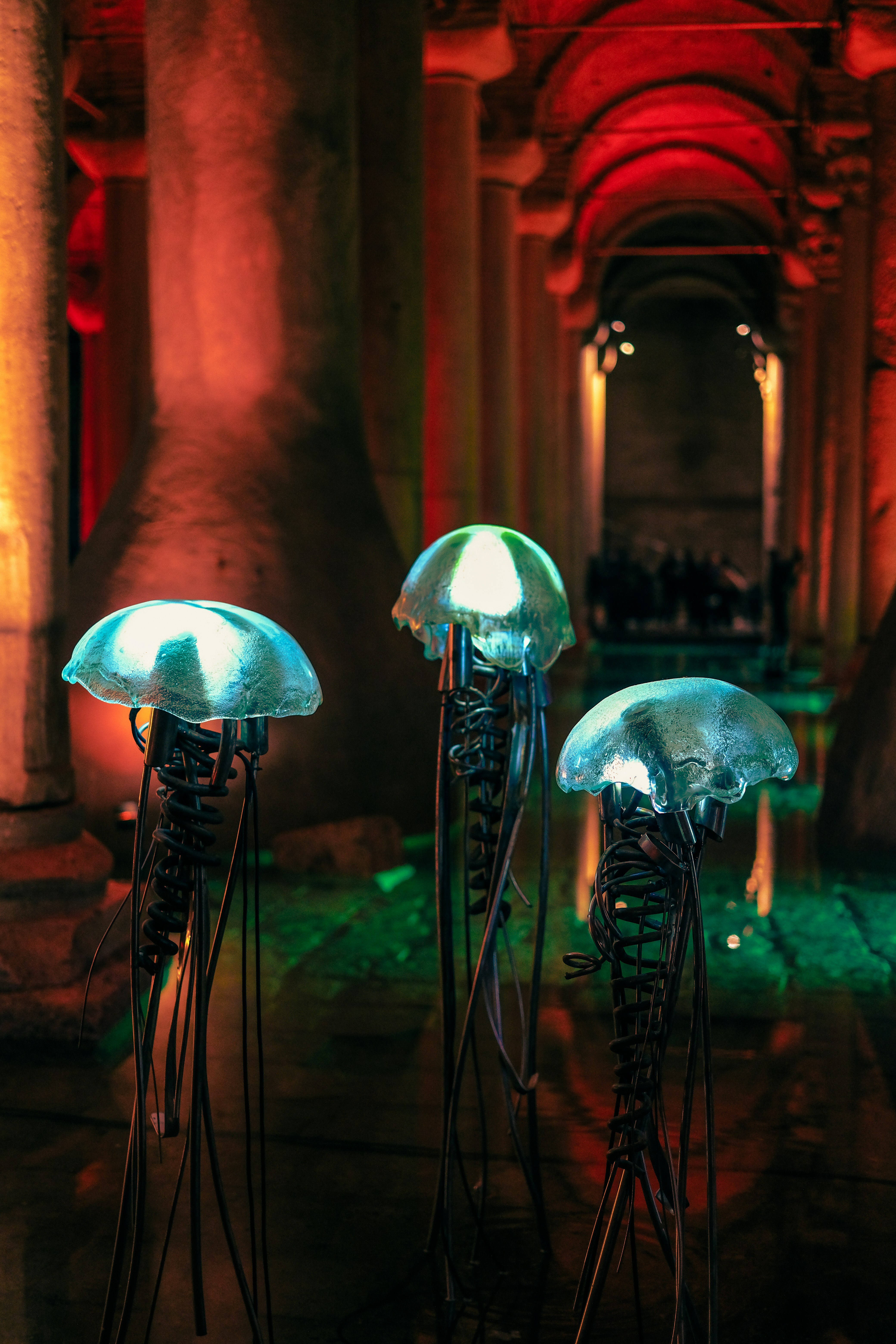 Neon Jellyfish in a Red Vault: A Corridor of Light and Cables