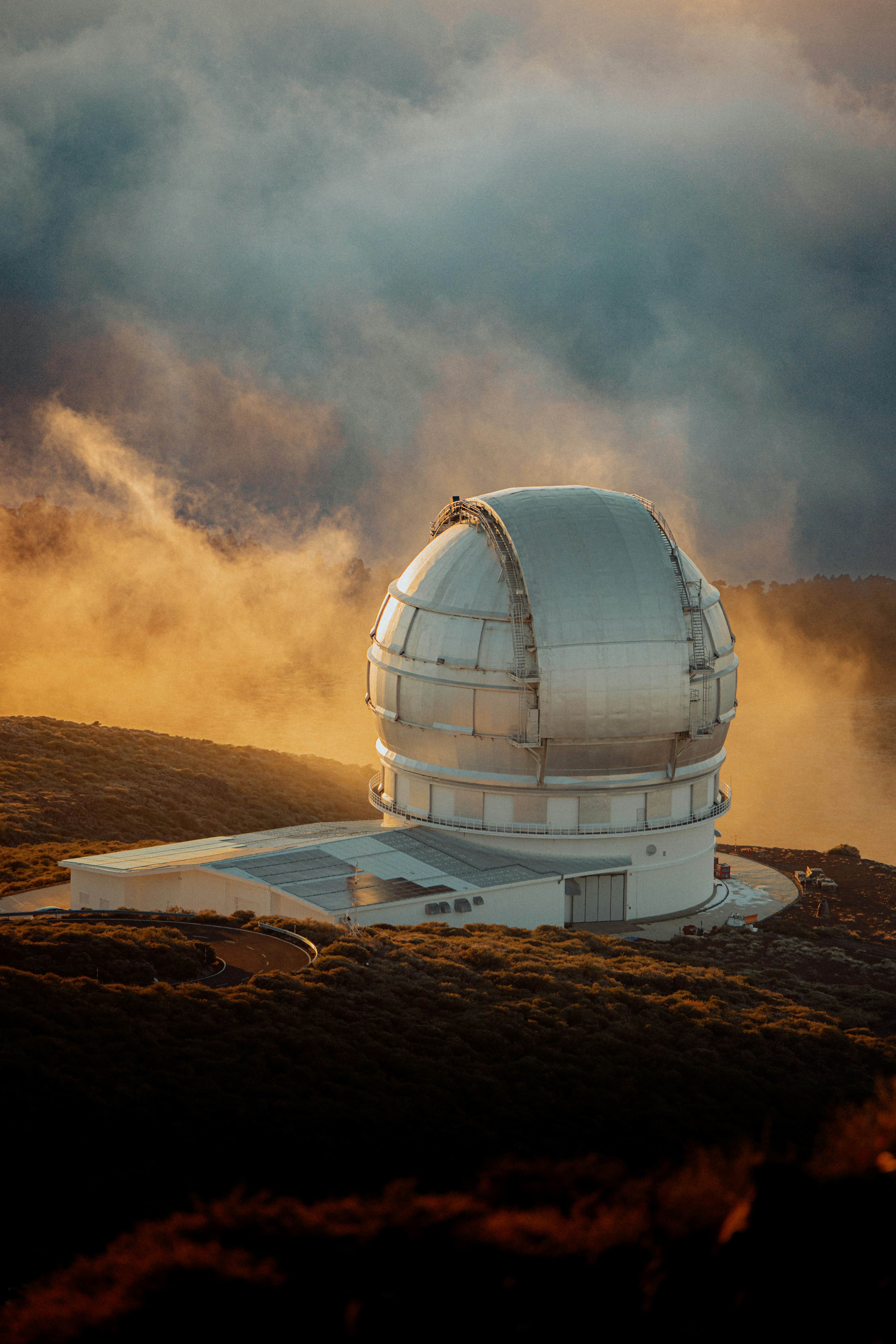 A large observatory under a cloudy, golden sky. photo – Free Building ...