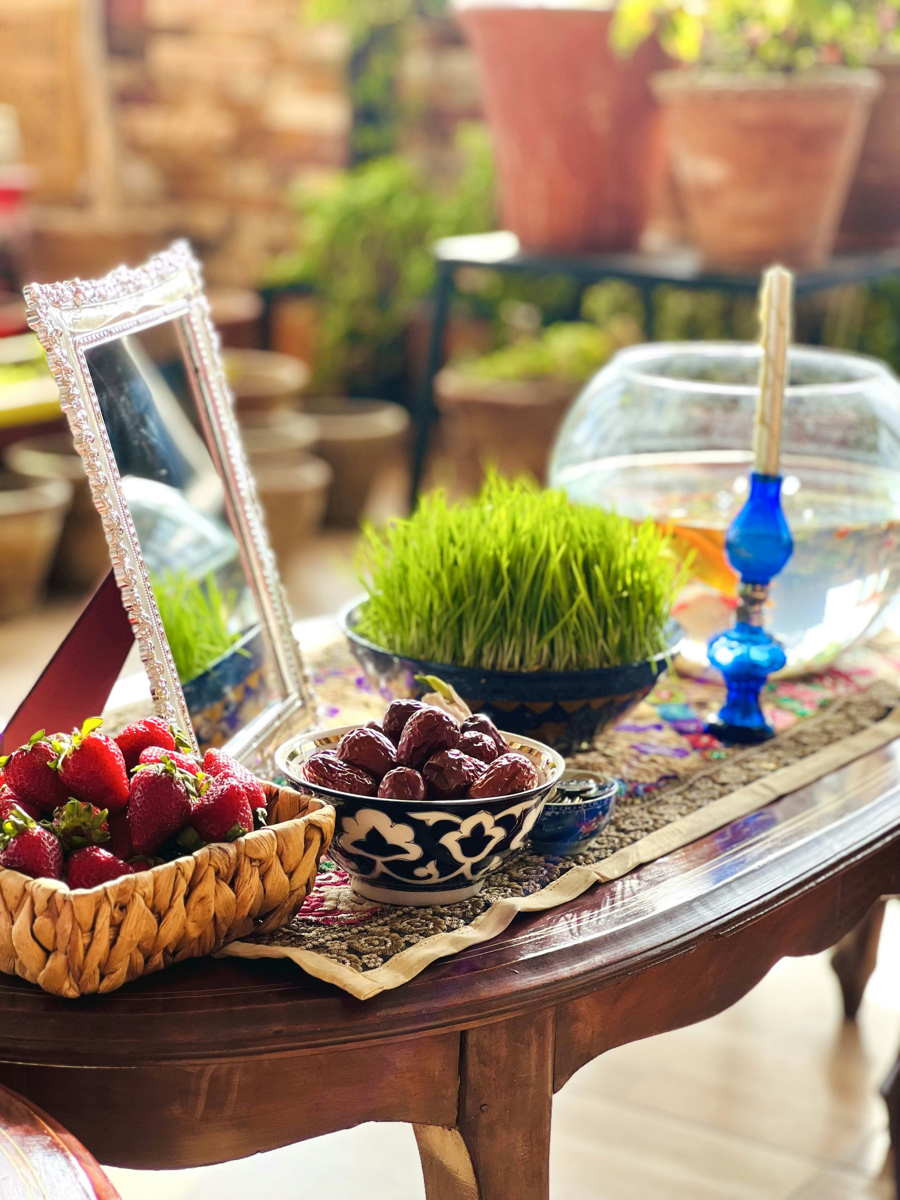 Verdant Centerpiece Amid Berries and Glass on a Sunlit Table