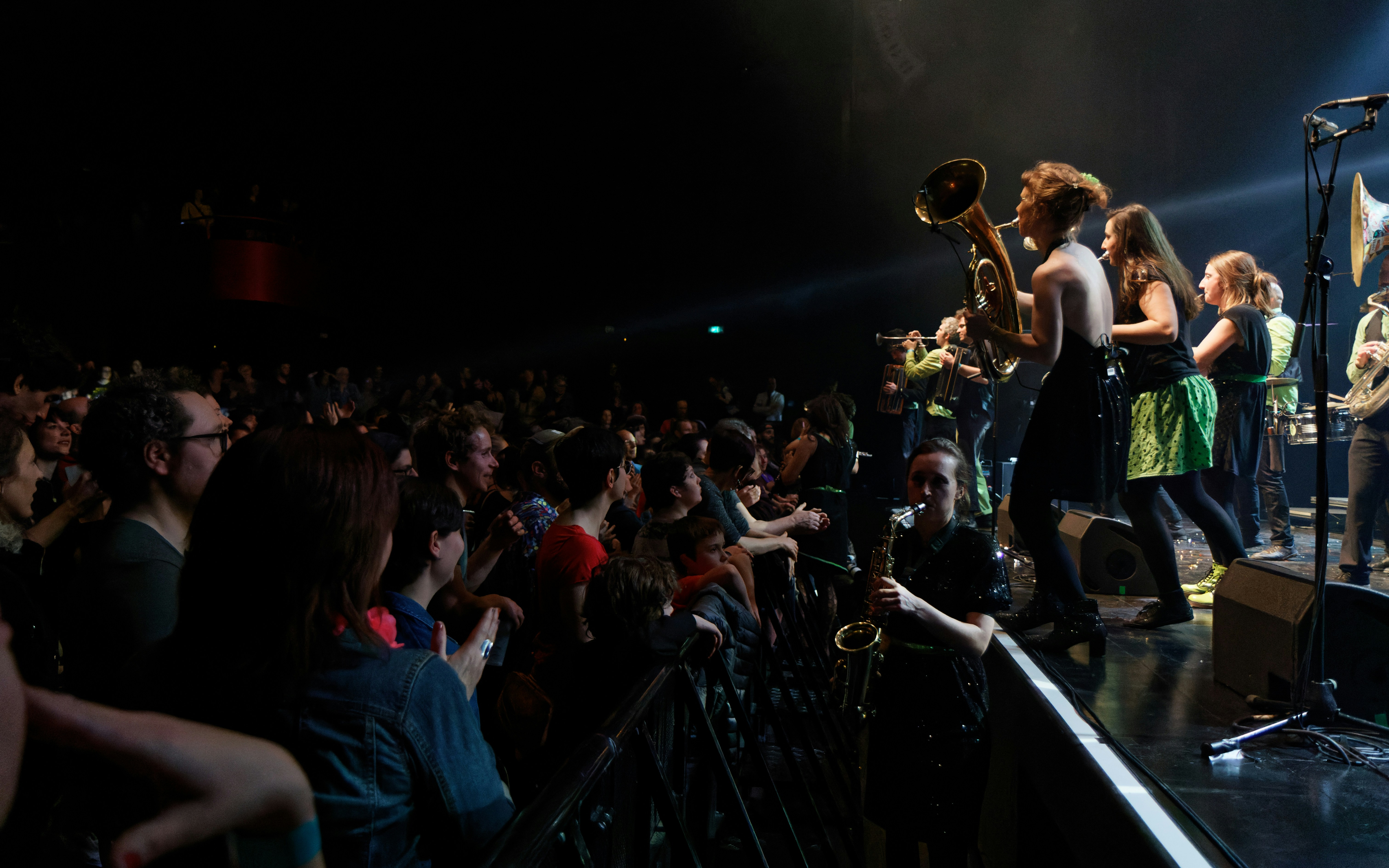 A band performs on stage for a large crowd. photo – Free Woman Image on ...