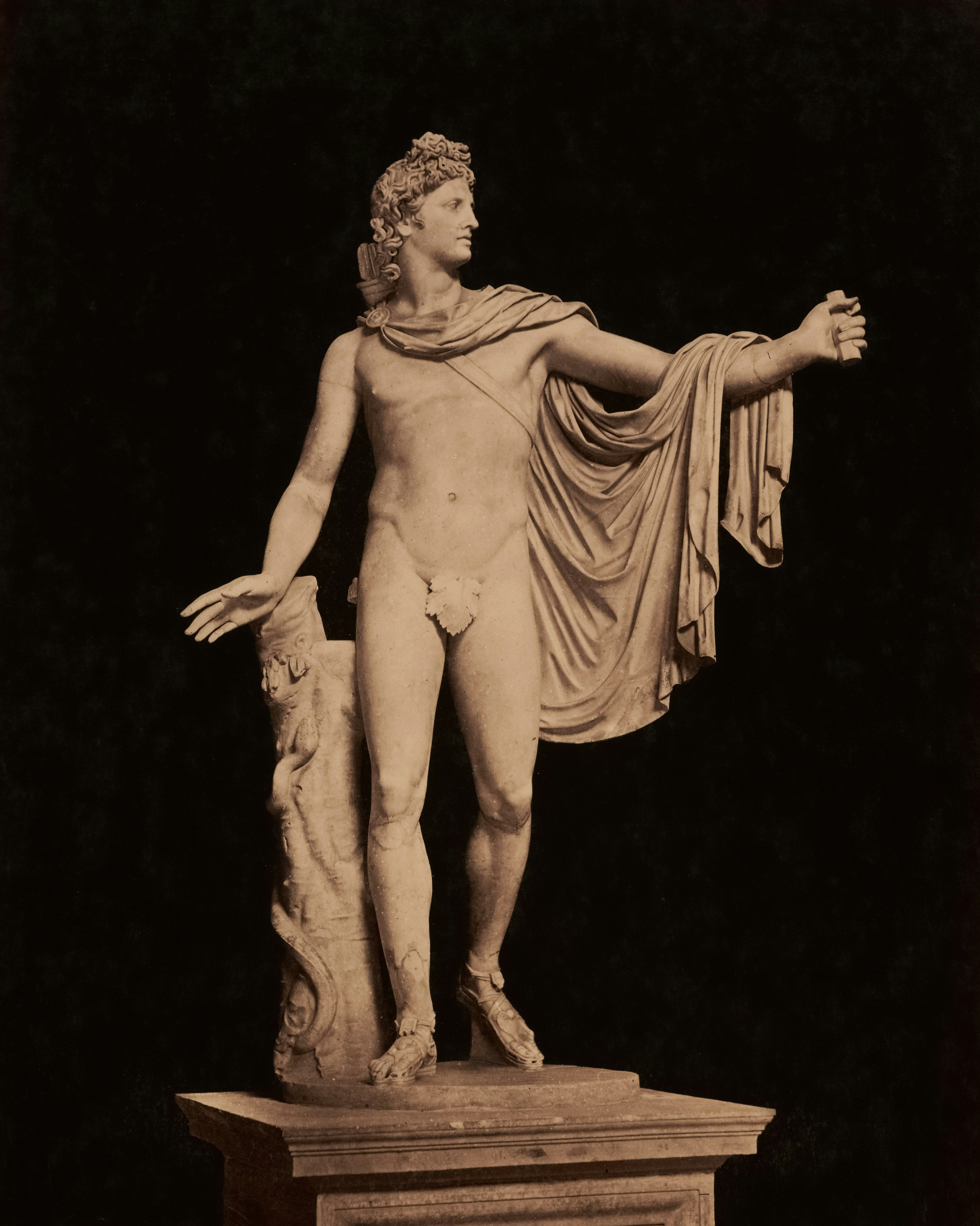Classical marble statue of a youthful figure, draped elegantly, exuding a sense of authority and grace.