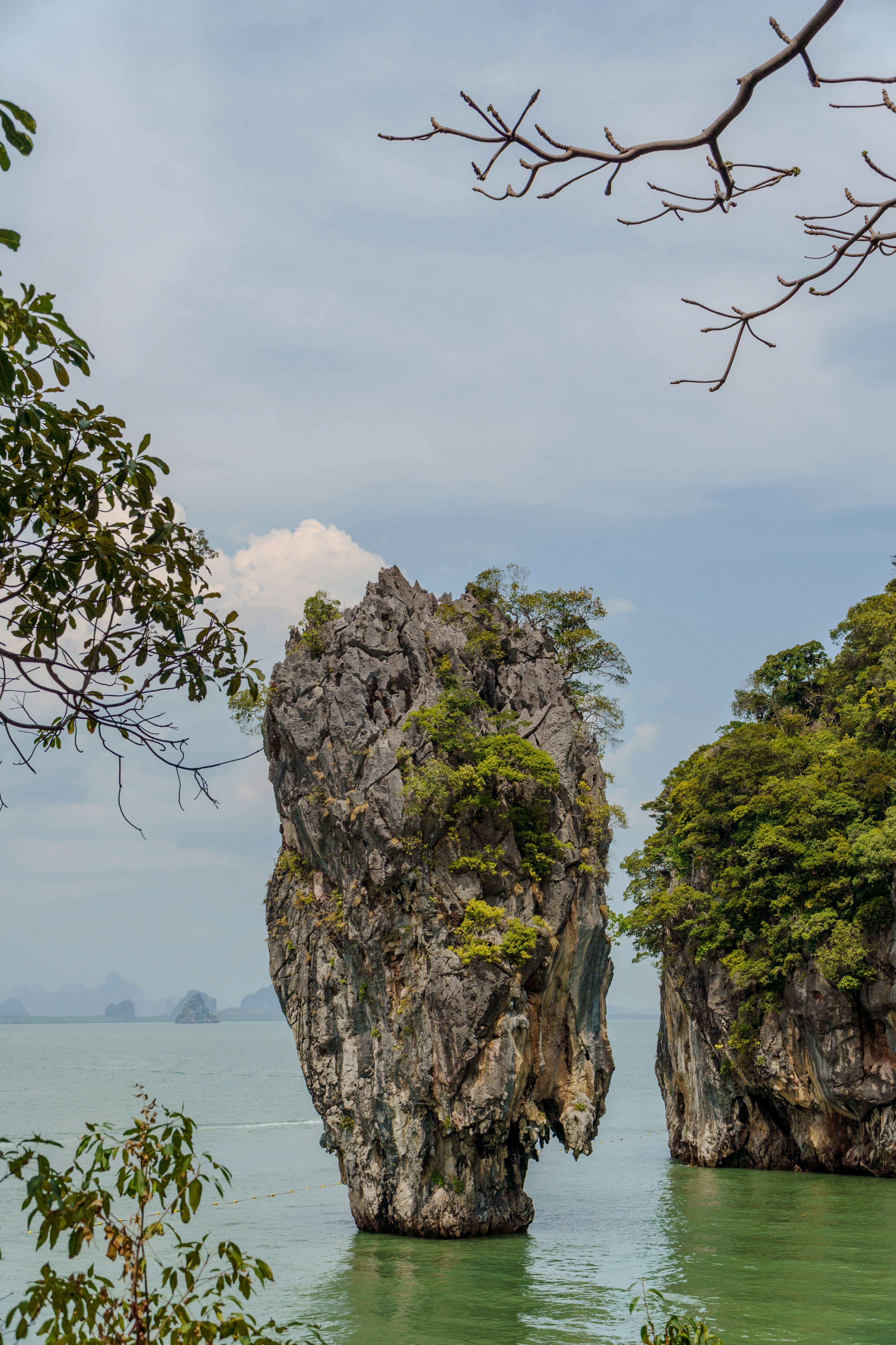 A tall limestone rock formation sits in the water. photo – Free Land ...