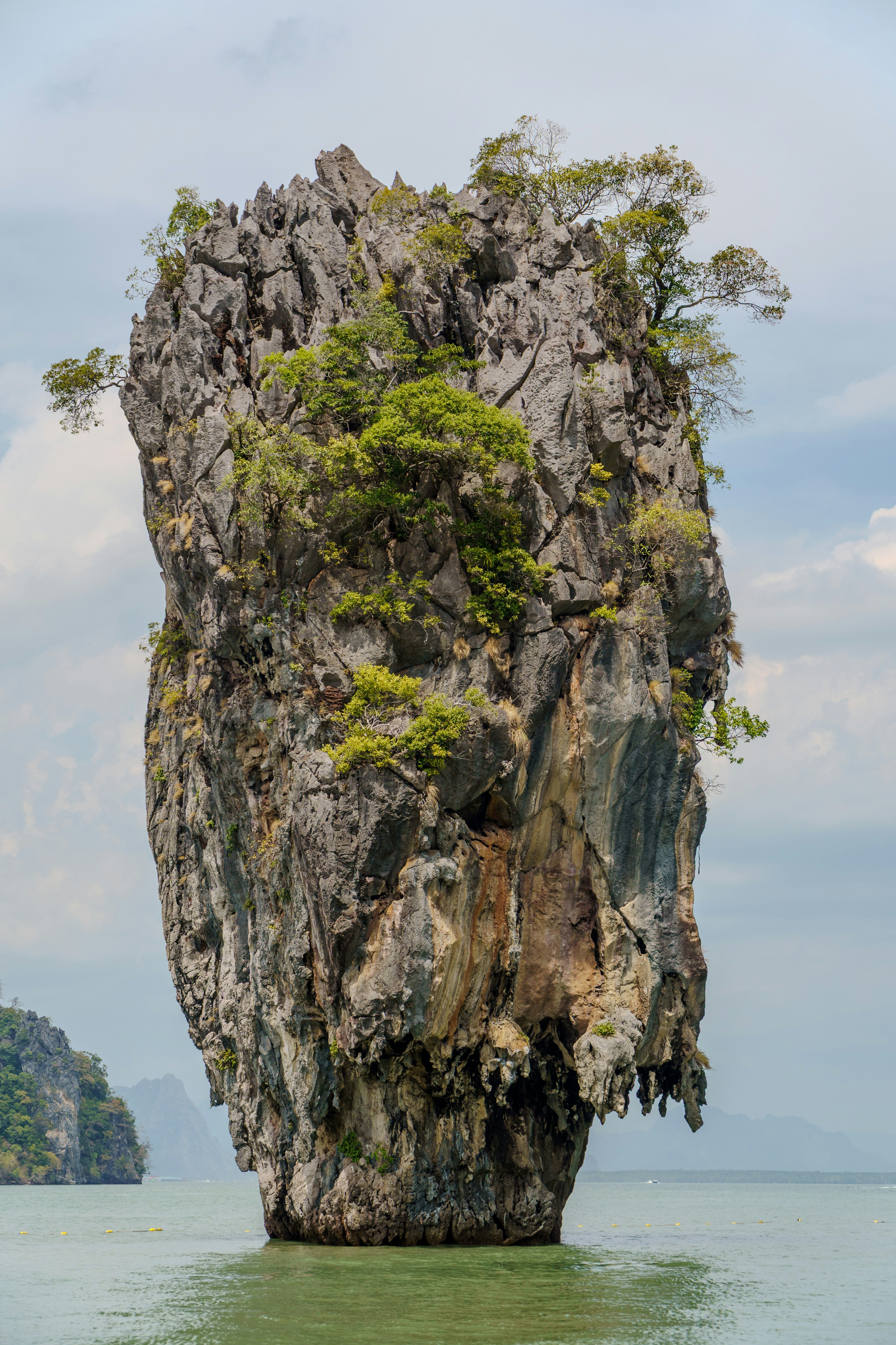 A striking limestone island rises from the ocean. photo – Free Land ...