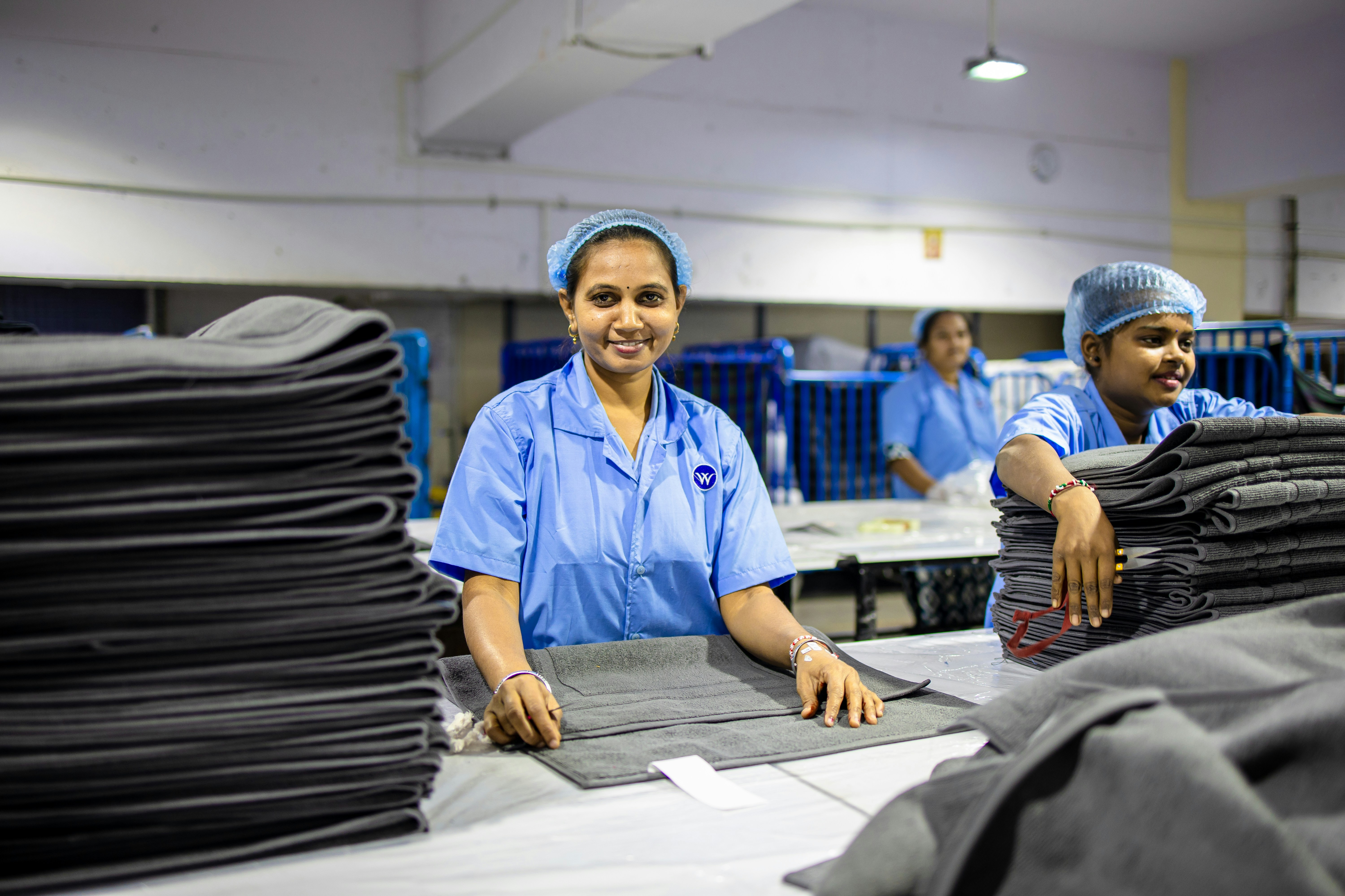Workers fold clothing in a factory. photo – Free Woman Image on Unsplash
