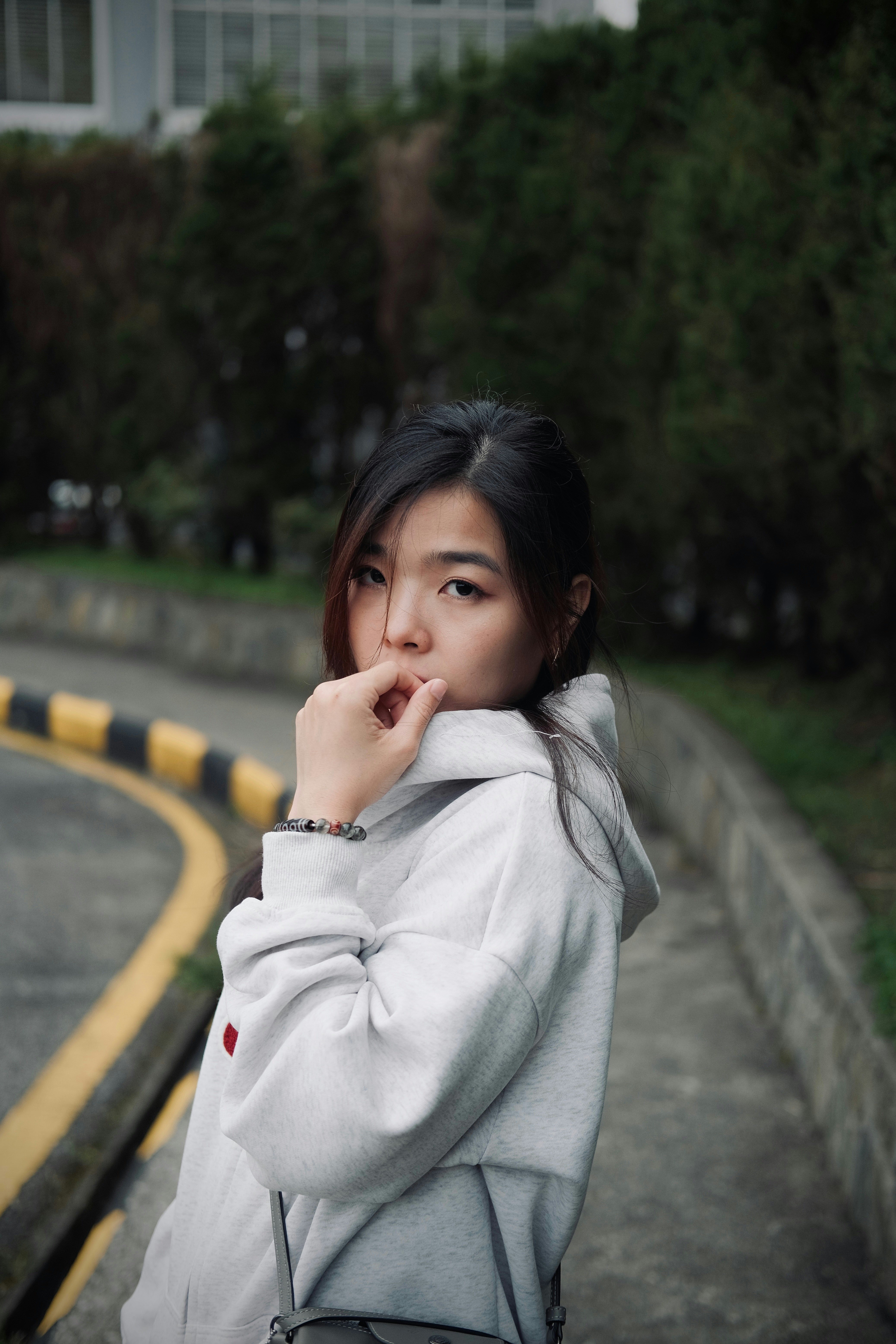 A young woman outdoors, posing for the camera.