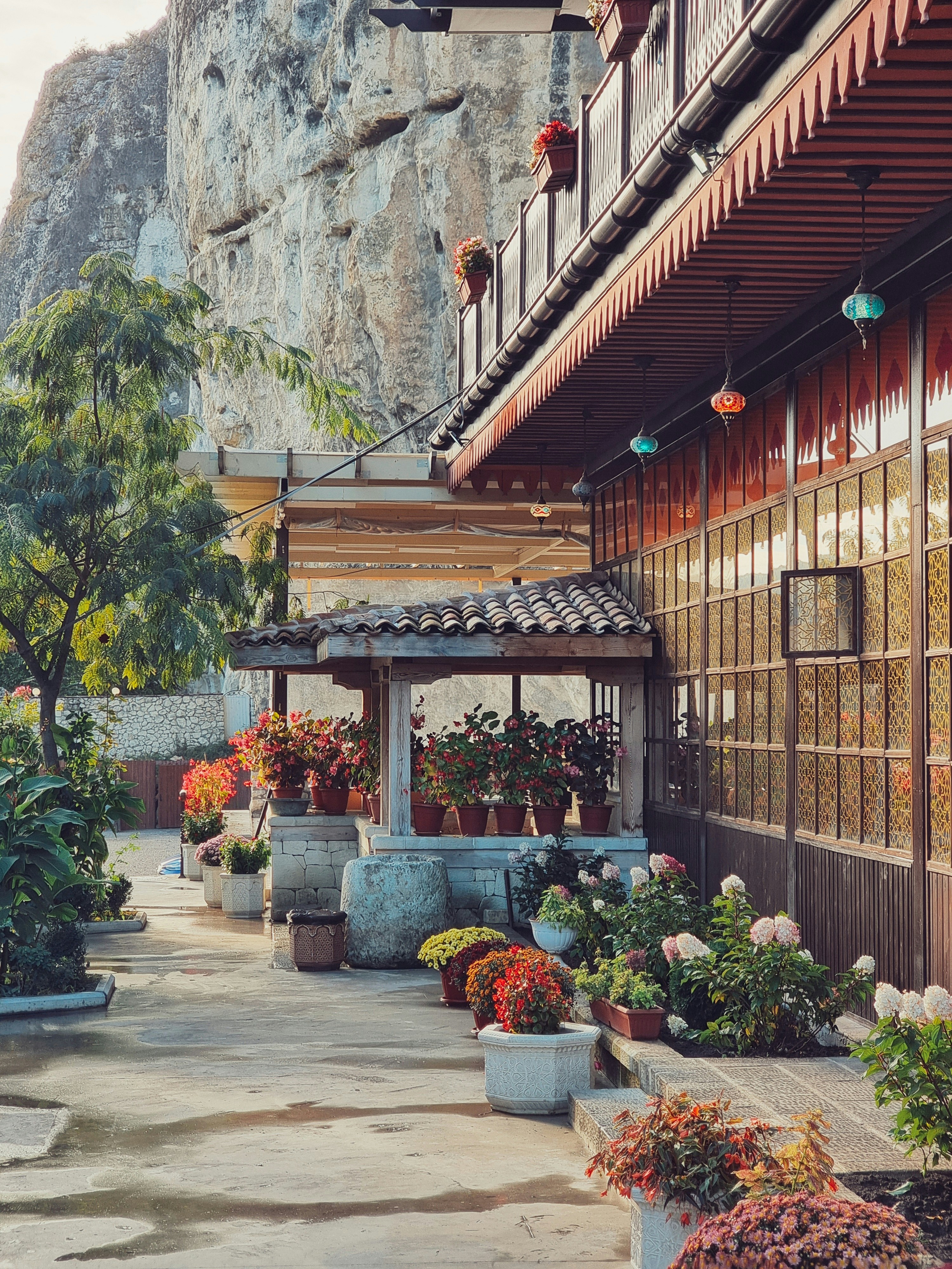 Garden Courtyard Beneath a Cliffside Veranda