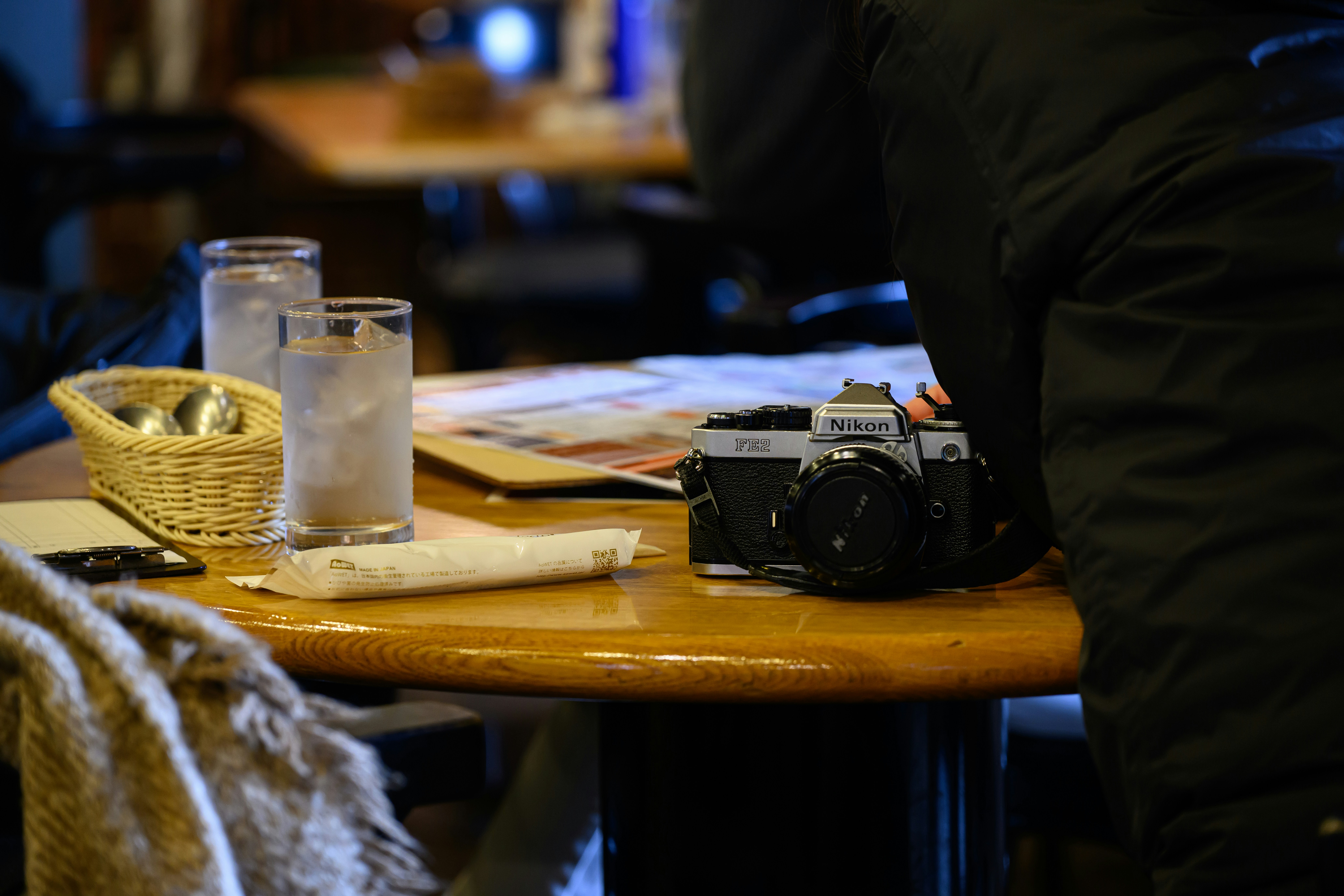 Nikon on a Quiet Café Table: A Moment of Craft and Light