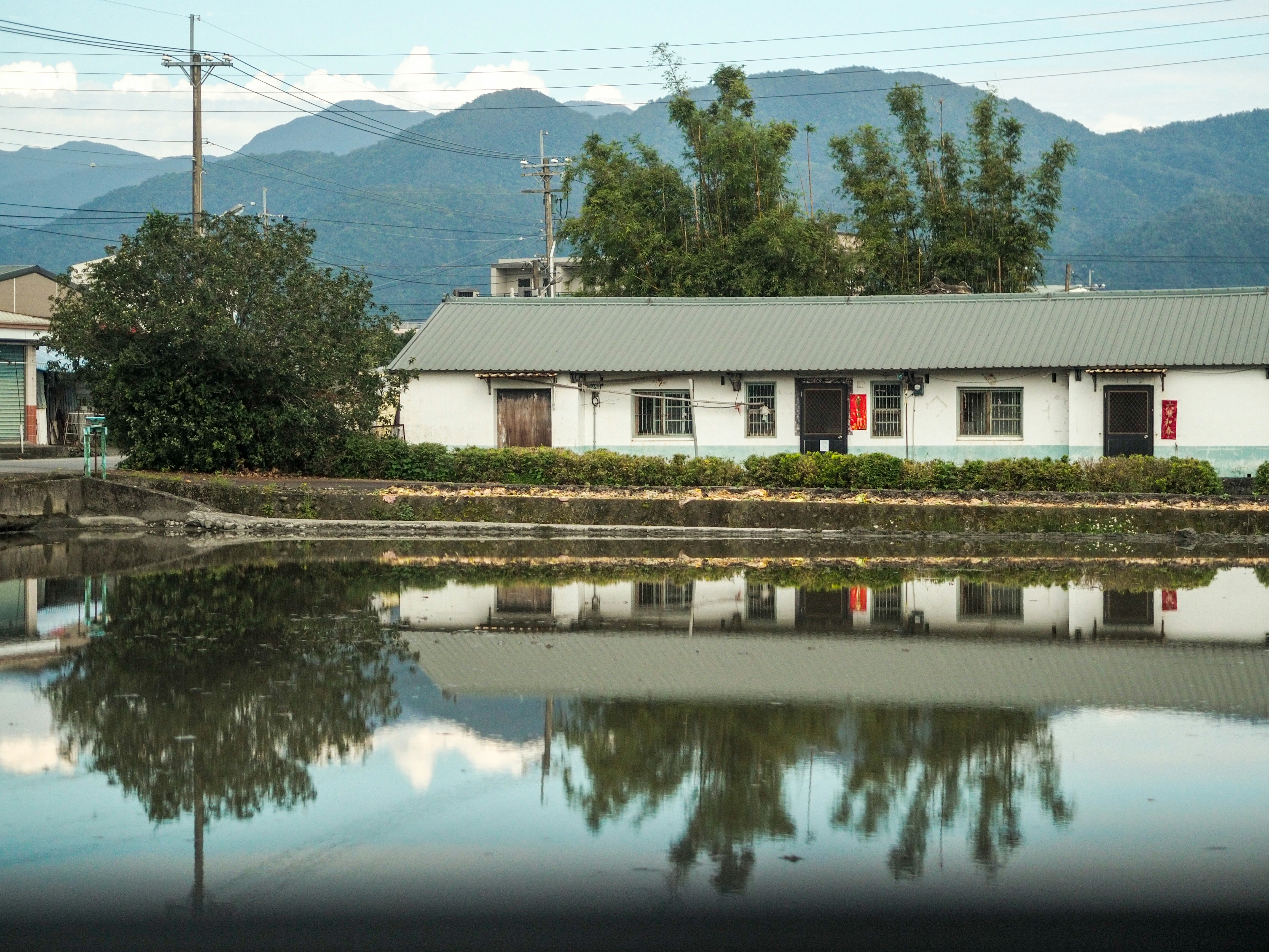 Serene Waterside Reflection in Mountain Village