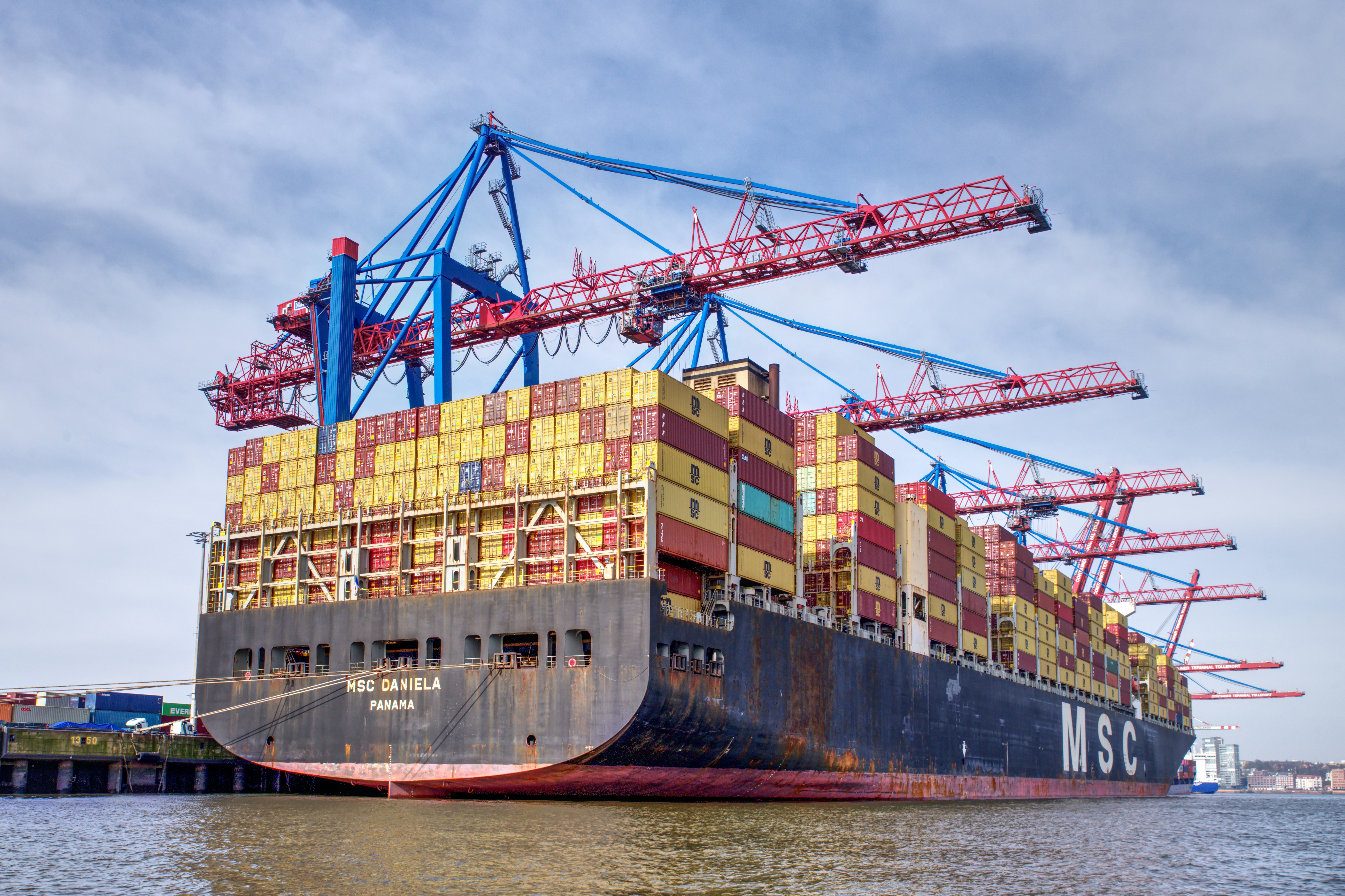 Cargo ship being loaded with containers at a port. photo – Free Boat ...
