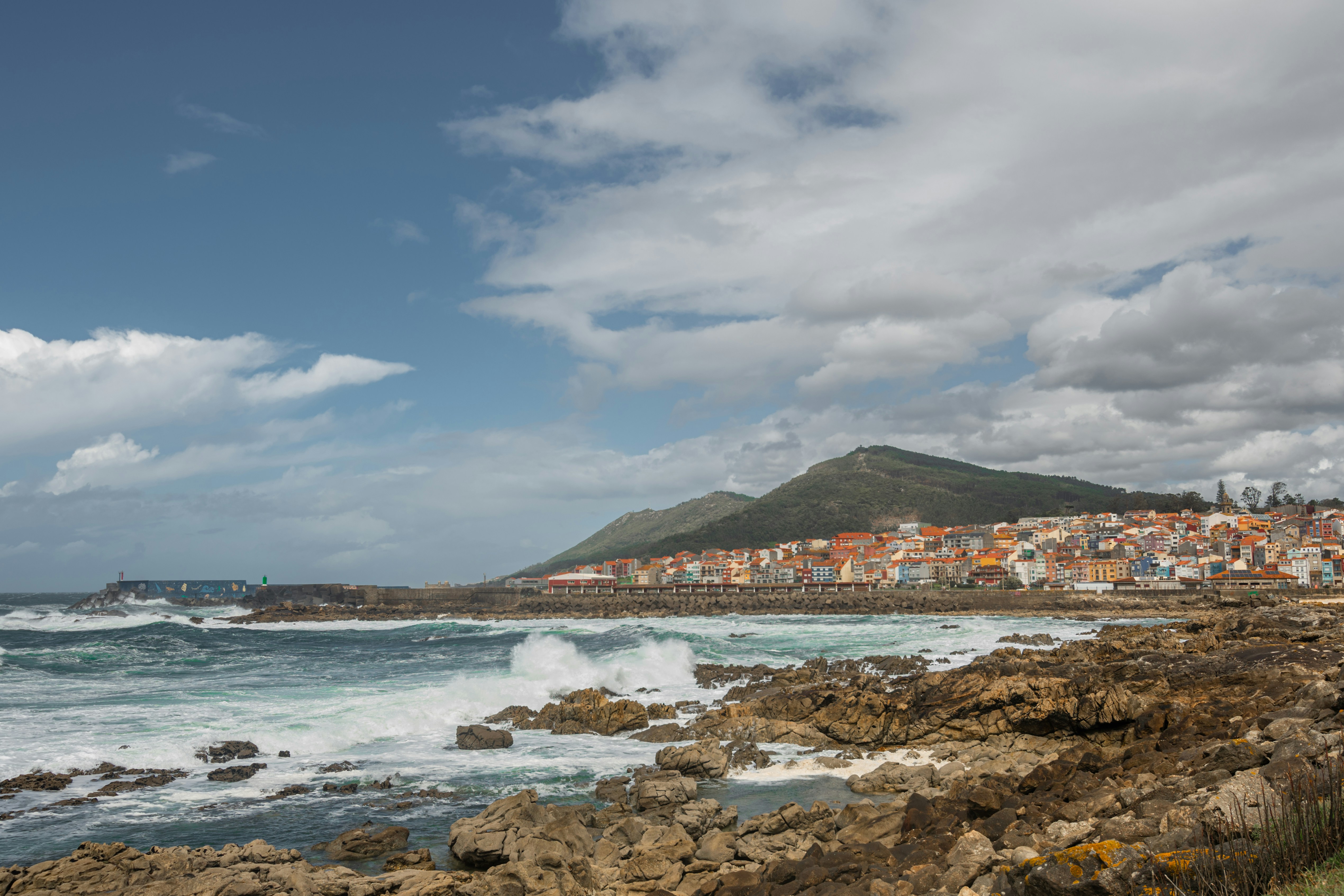Pastel Harbor along Wind-Sculpted Rocks