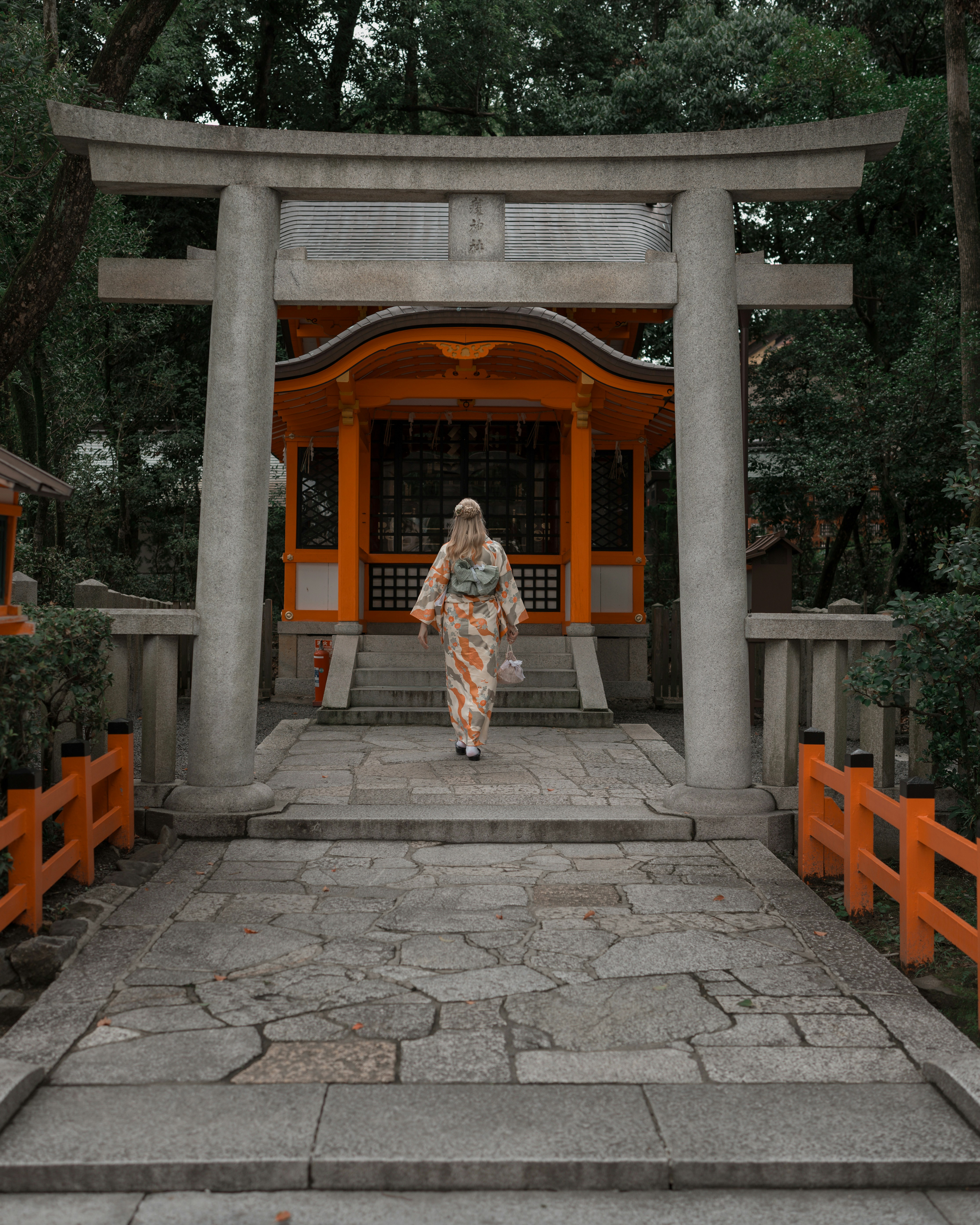 Footsteps Toward the Orange Shrine: A Solitary Moment Under the Torii