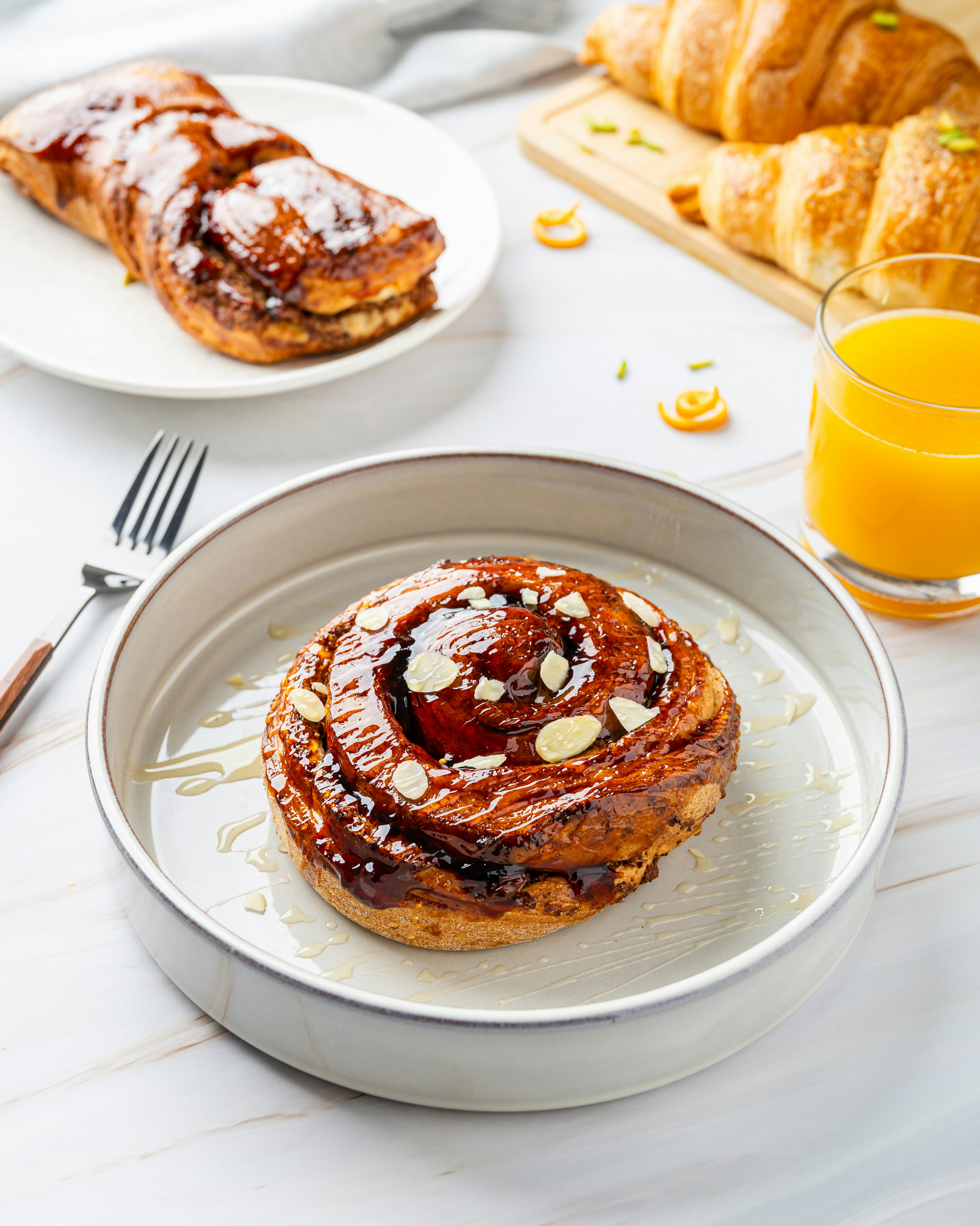 Delicious pastries, juice, and breakfast items are displayed. photo ...