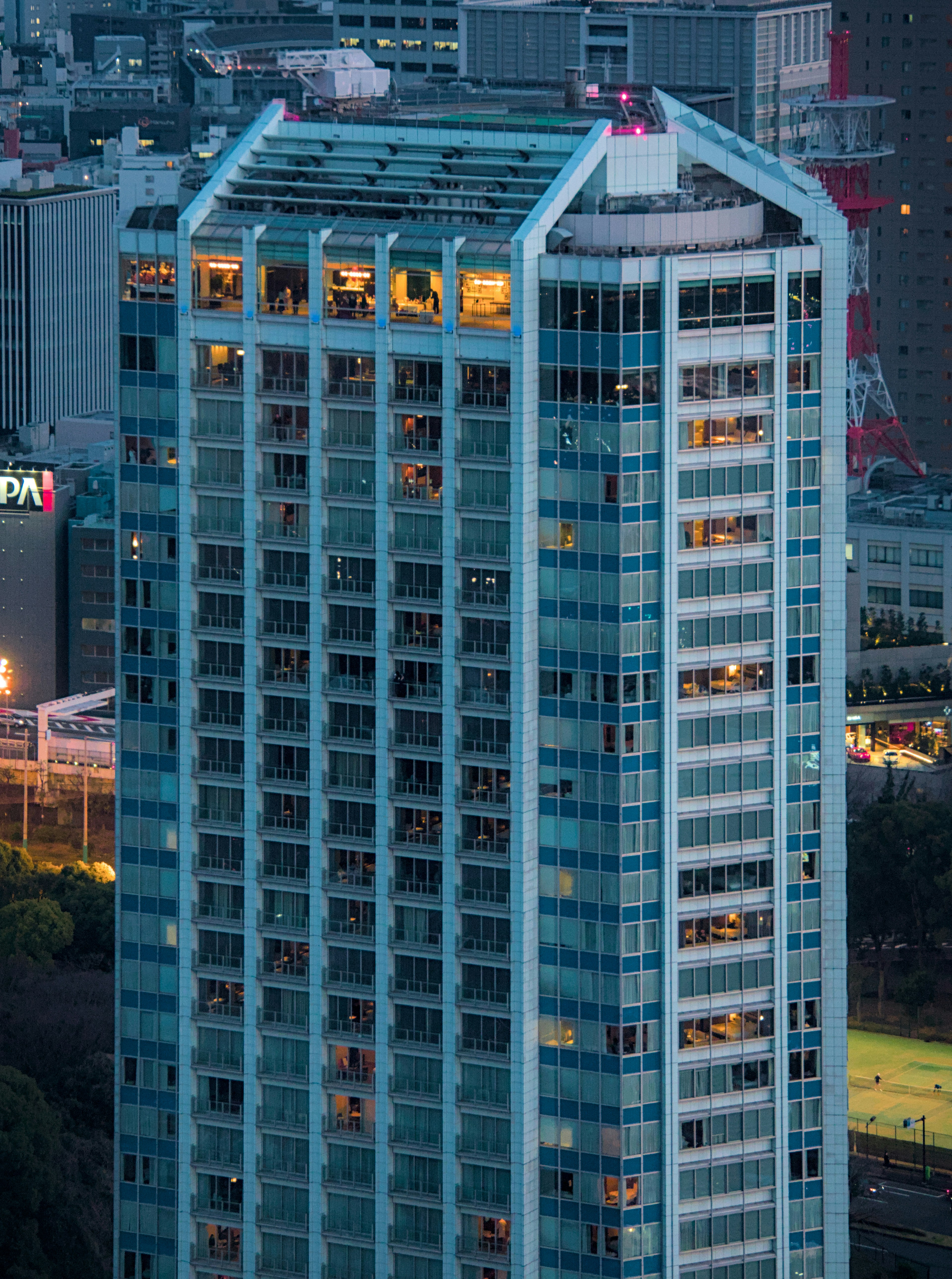 Azure Ledger: A Nighttime Tower Woven with Warm Windows