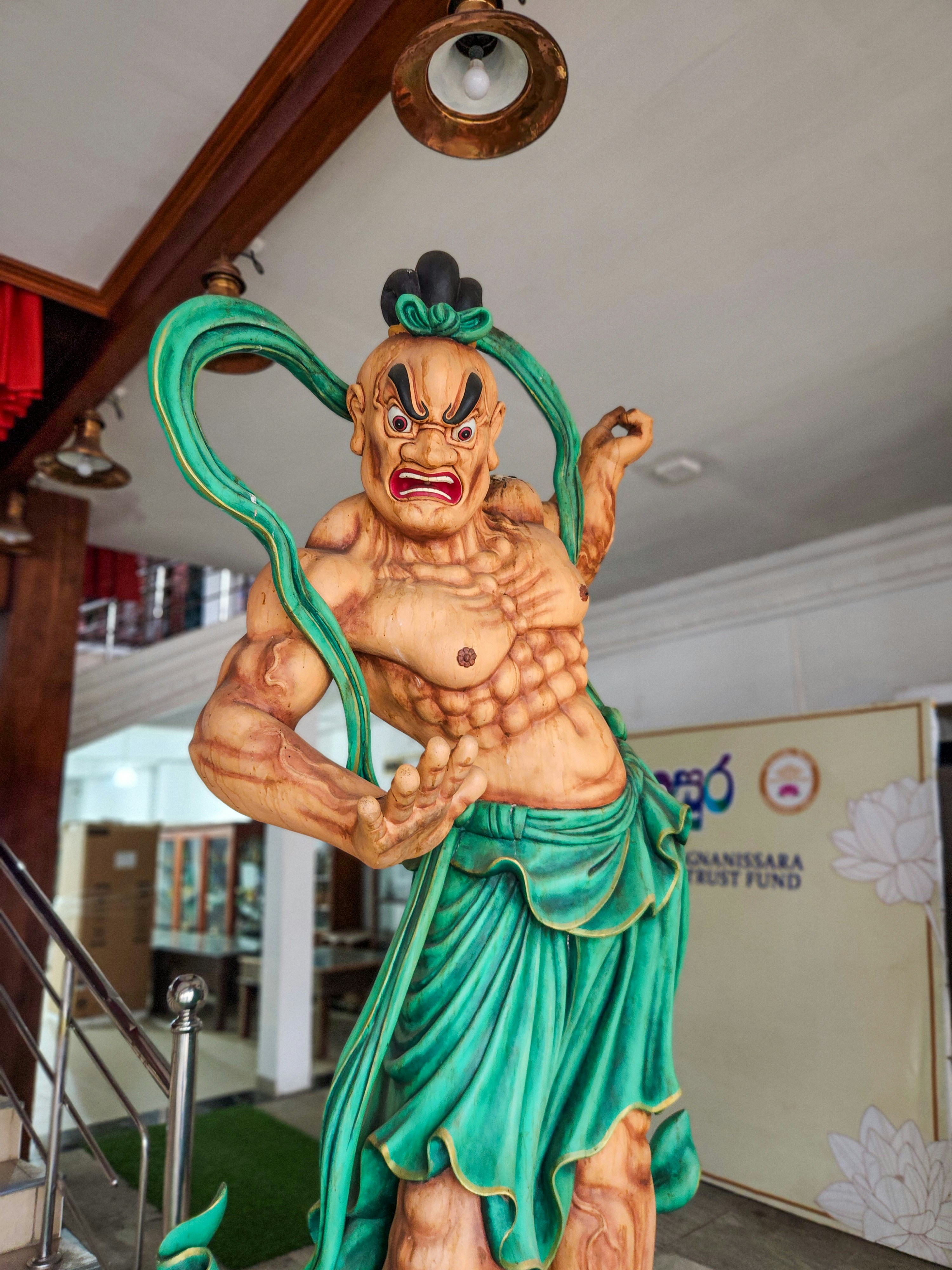 Statue of an angry deity with green flowing garb. photo – Free Art ...