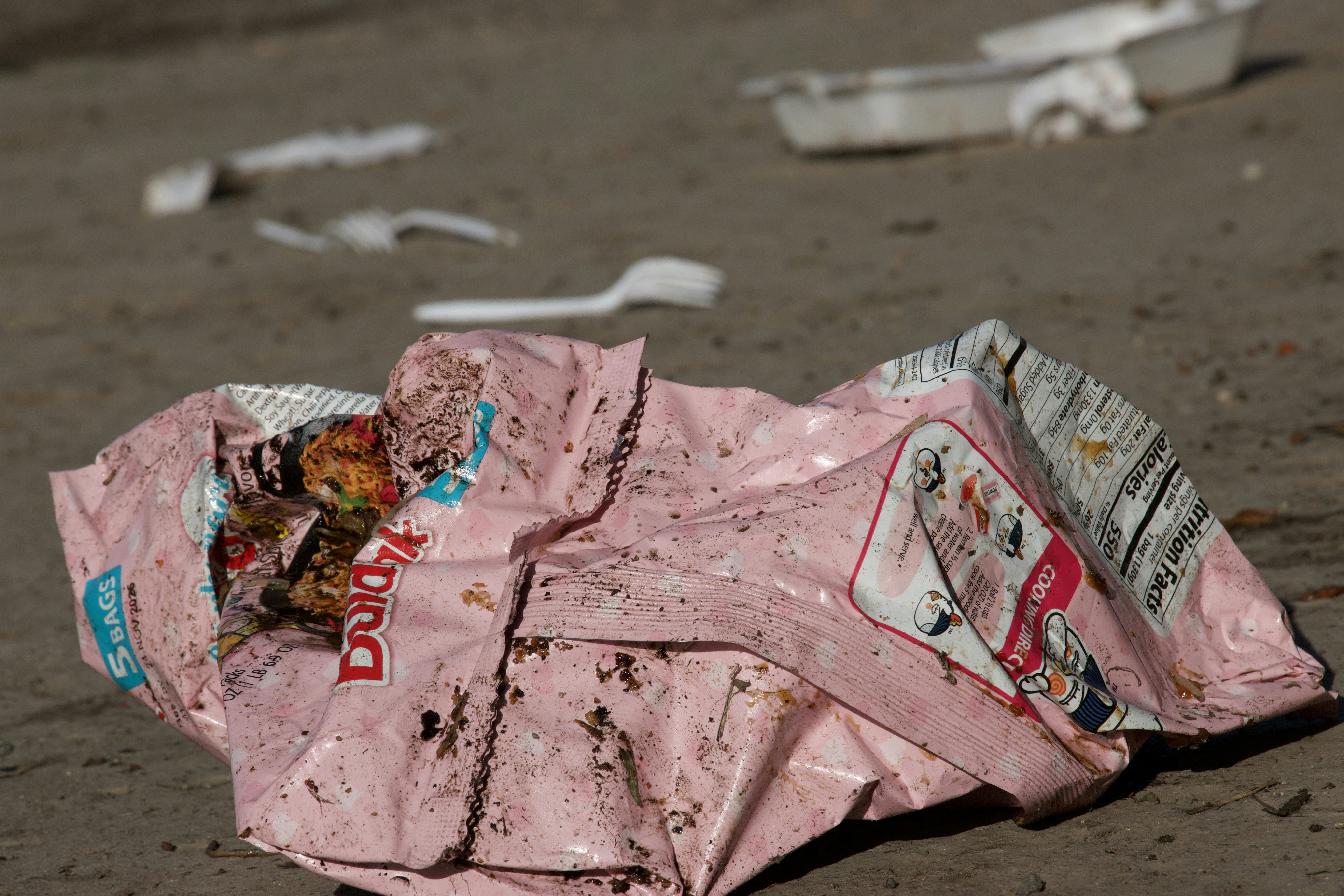 Litter and trash scattered on the ground. photo – Free Bag Image on ...