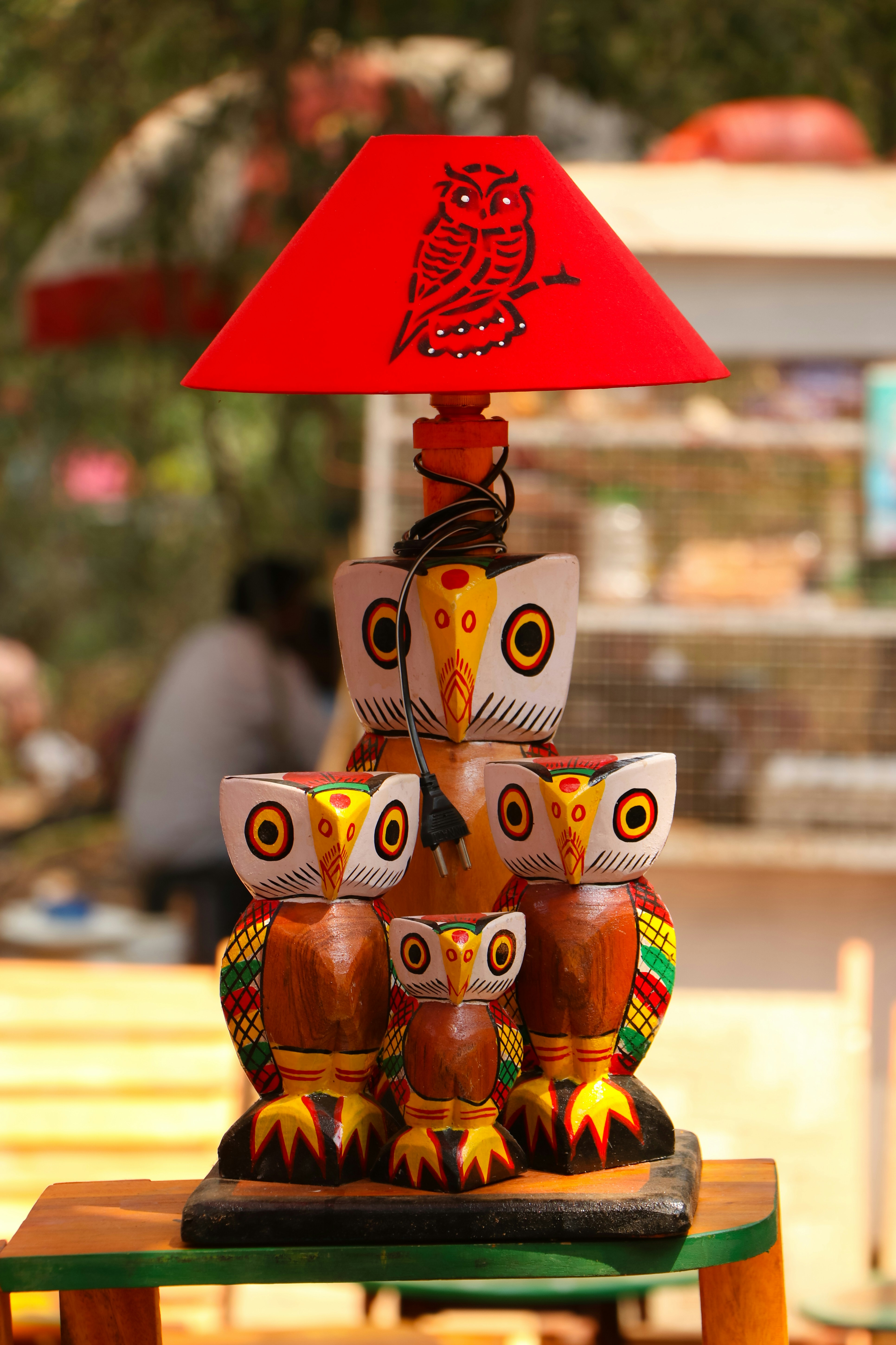 Owl Totem Lamp: A Colorful Stack of Carved Owls Under a Red Shade