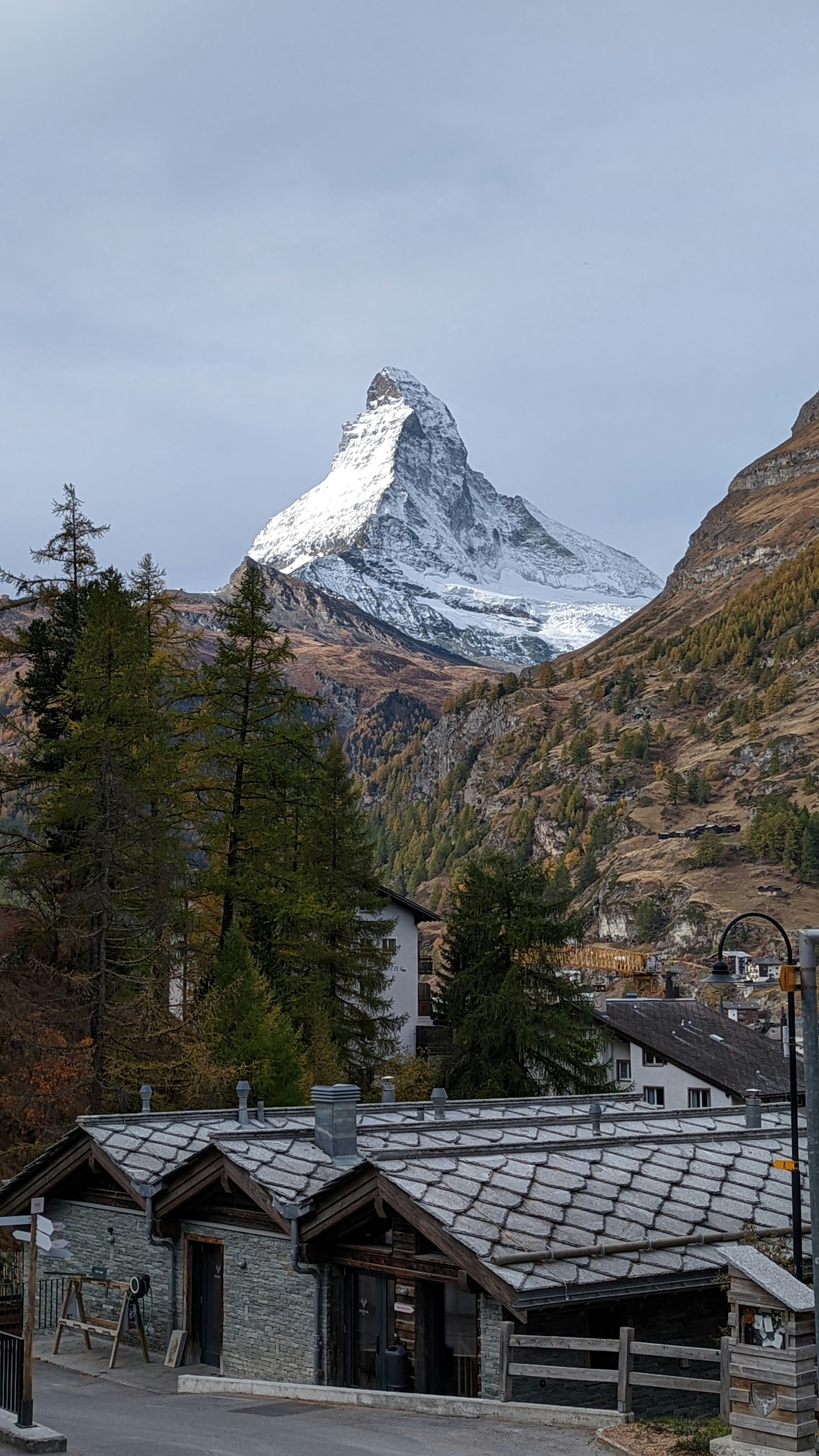 Snow-Crowned Peak Over a Timber Alpine Village