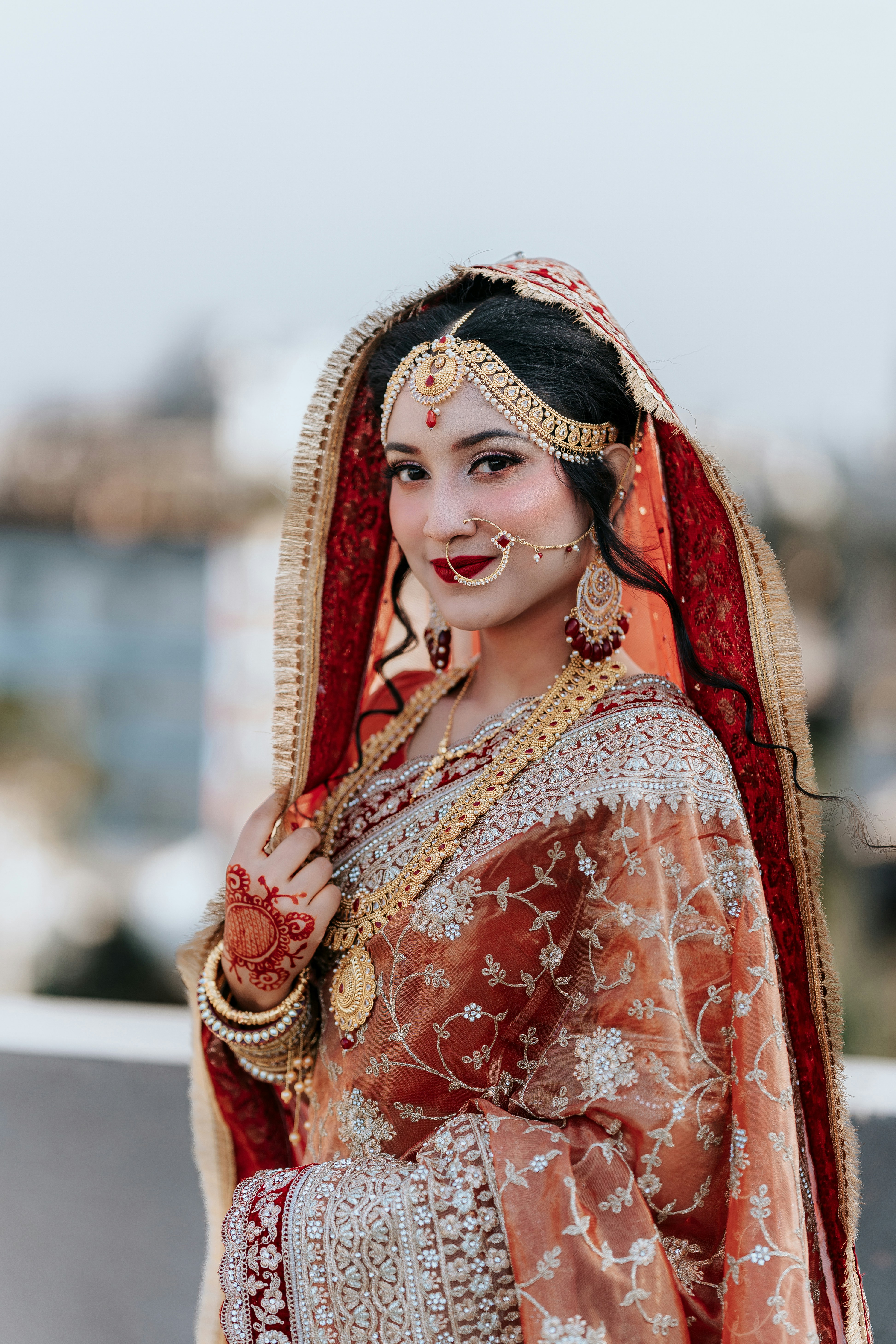 A bride poses in traditional wedding attire. photo – Free Wedding Image ...