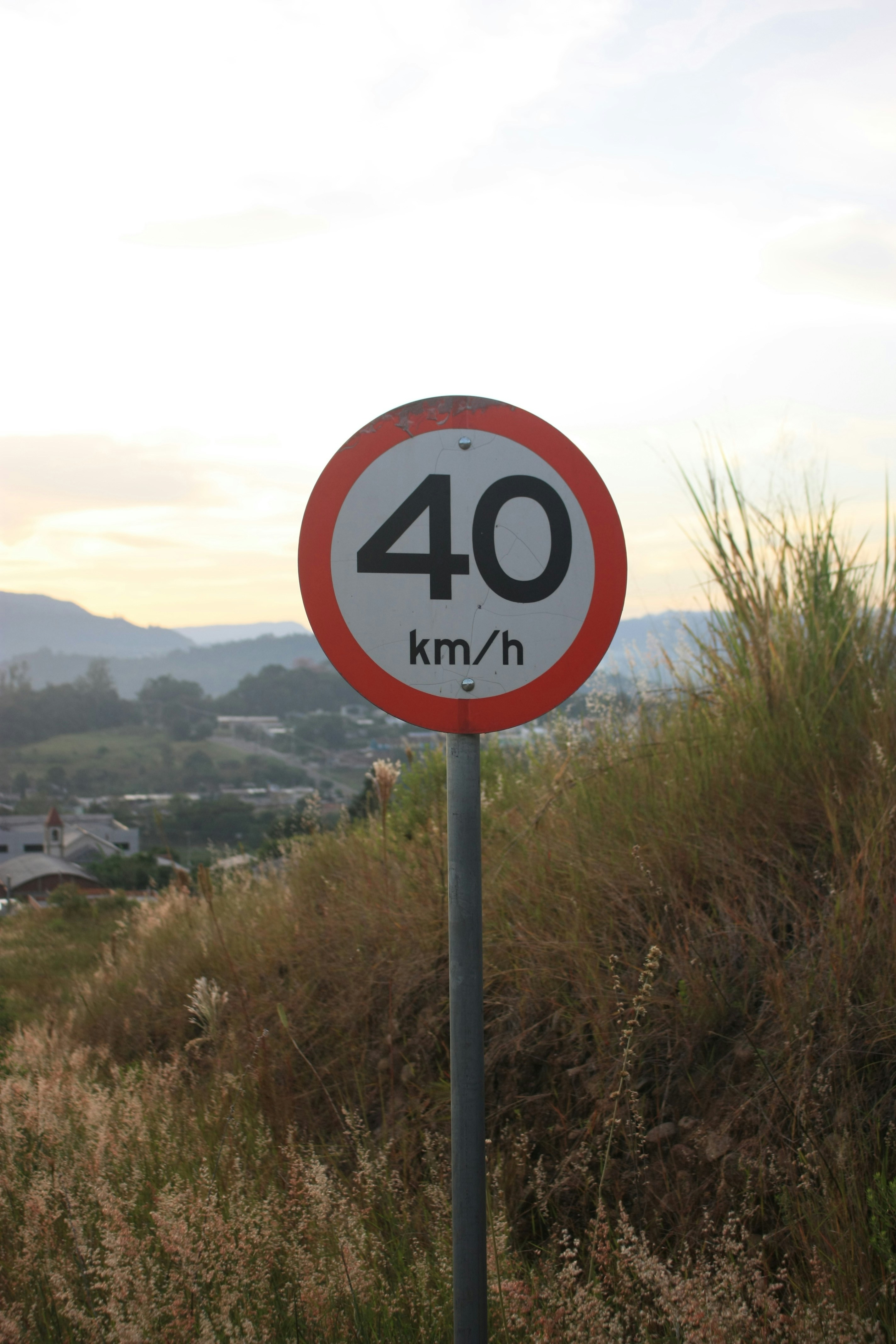 Forty on the Hill at Dusk: A Signpost Framing a Quiet Valley