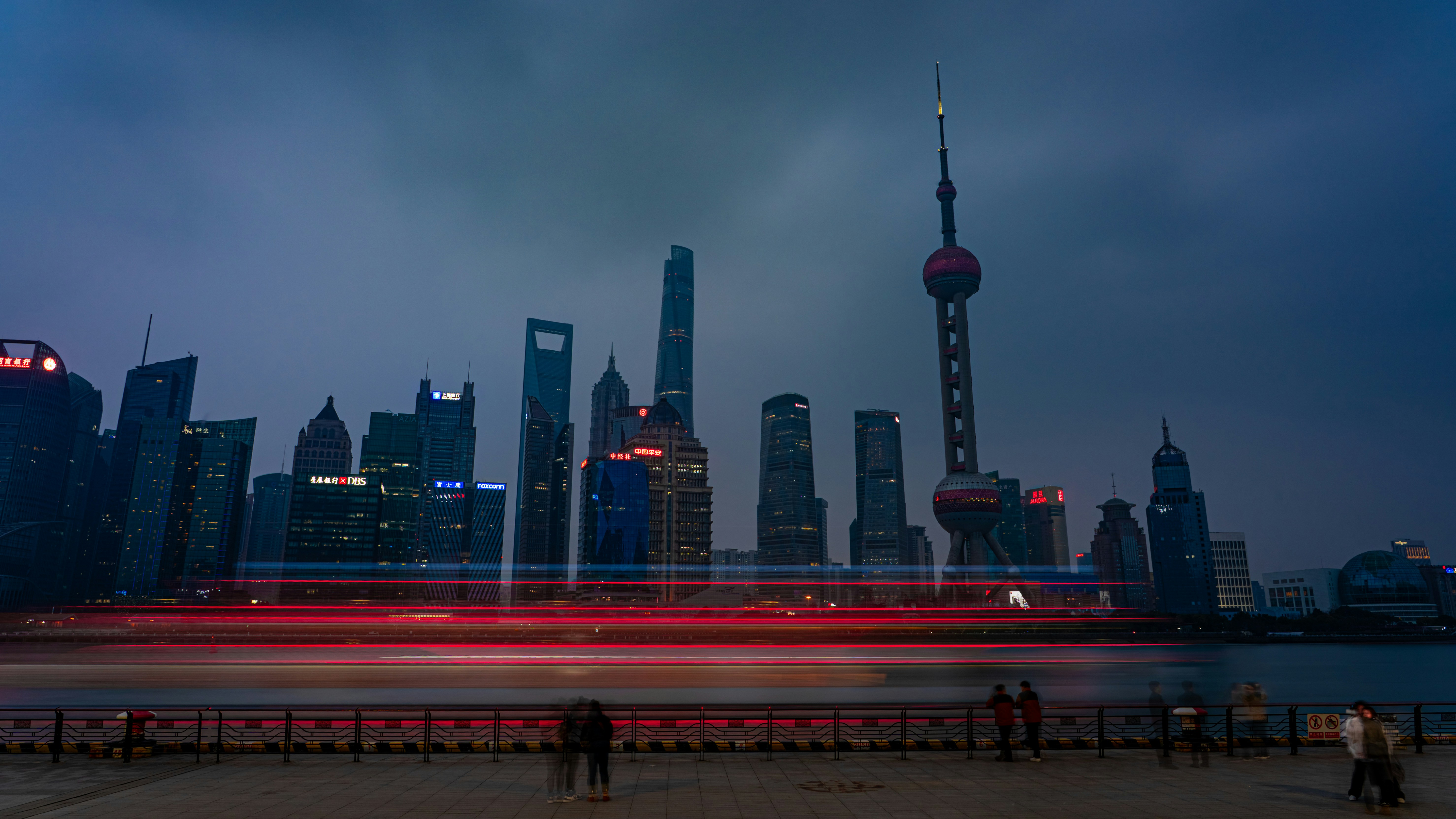 Shanghai skyline with the Oriental Pearl Tower under a moody evening sky.