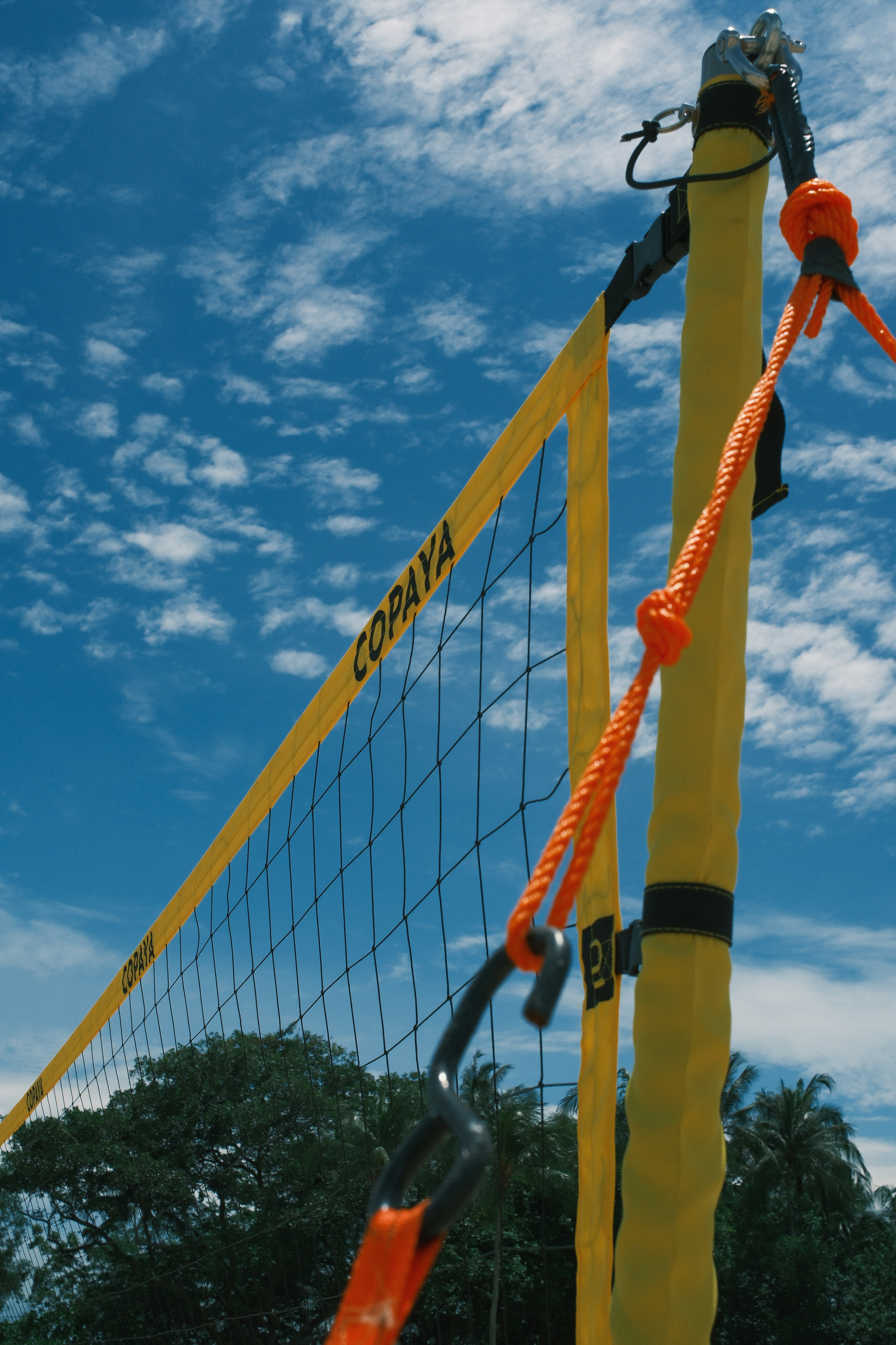 Volleyball net set up against a blue sky.