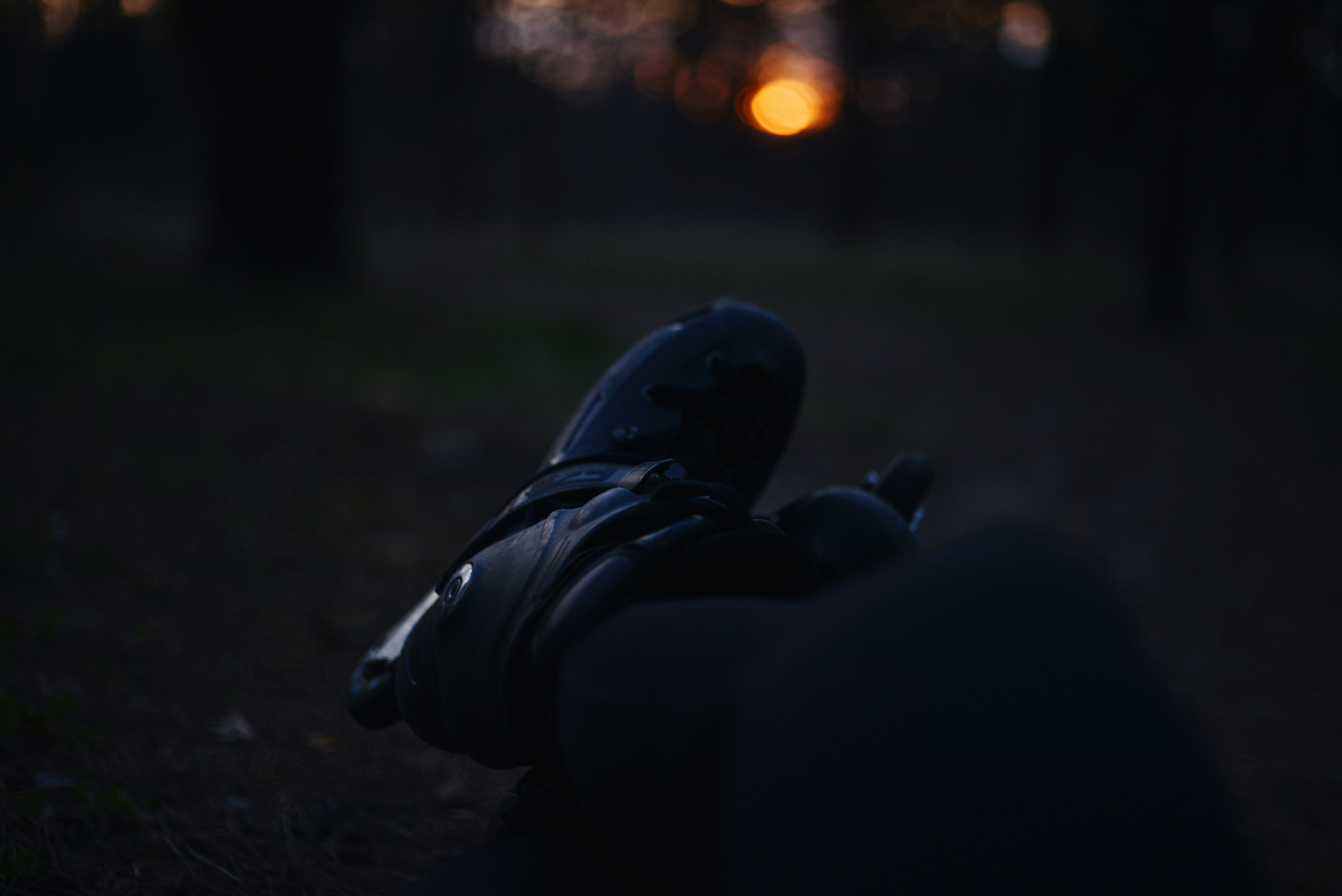 Low-Light Portrait of a Gear-Draped Figure in a Dusk-Wed Forest