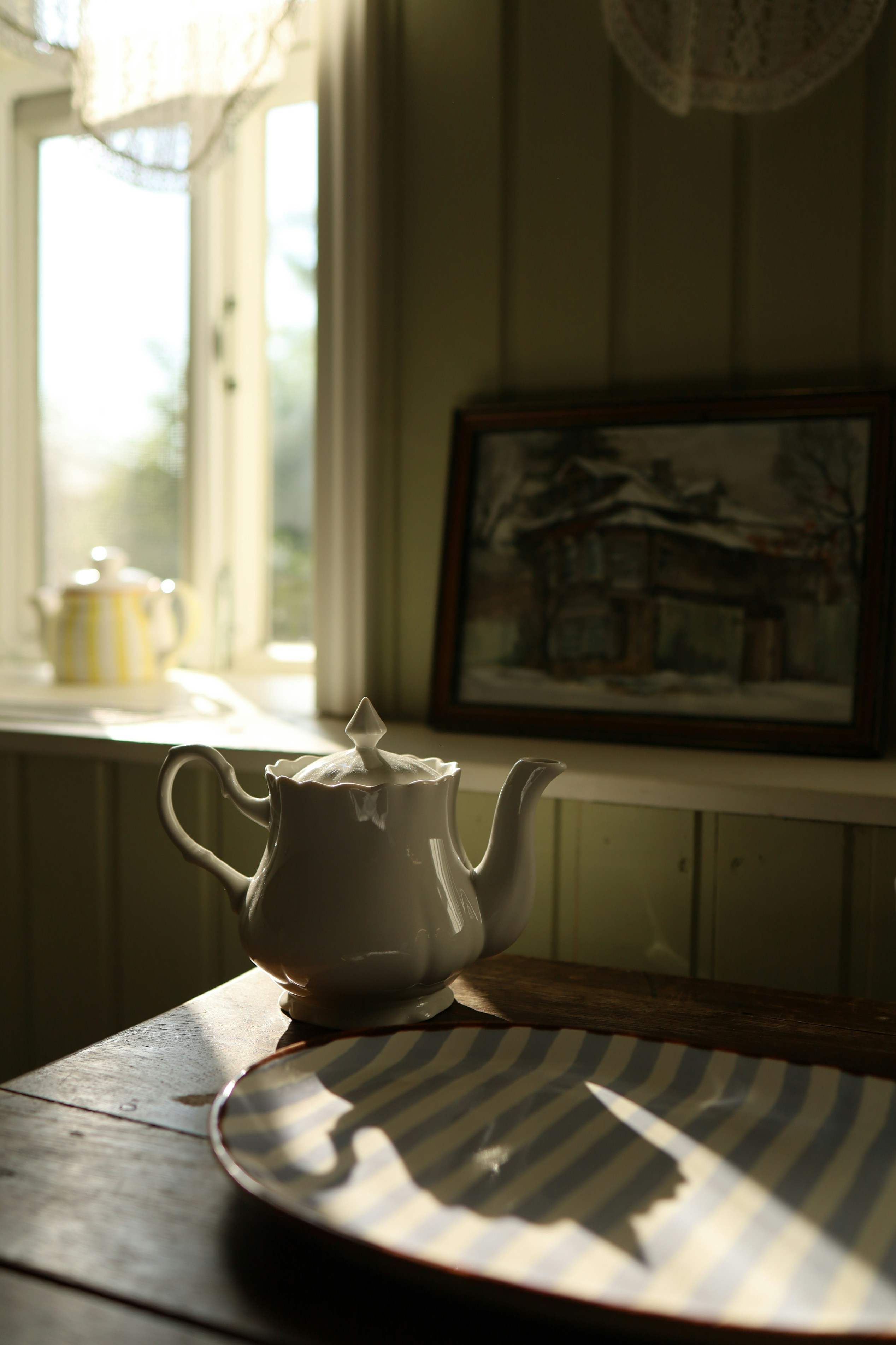 Sunlit Porcelain: A Teapot Anchoring Morning Light in a Cozy Kitchen