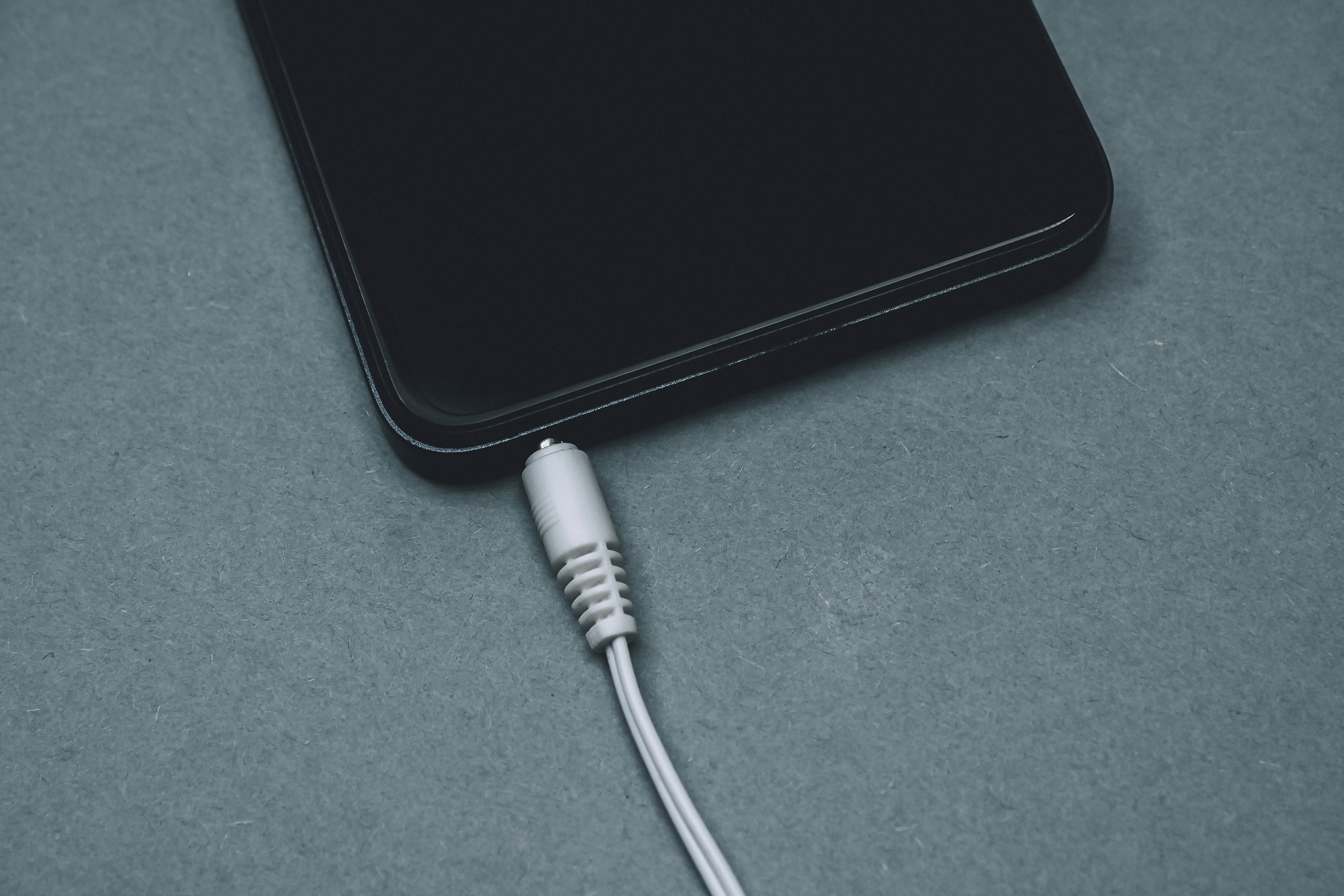 A phone is being charged with a charging cable. photo – Free Audio ...