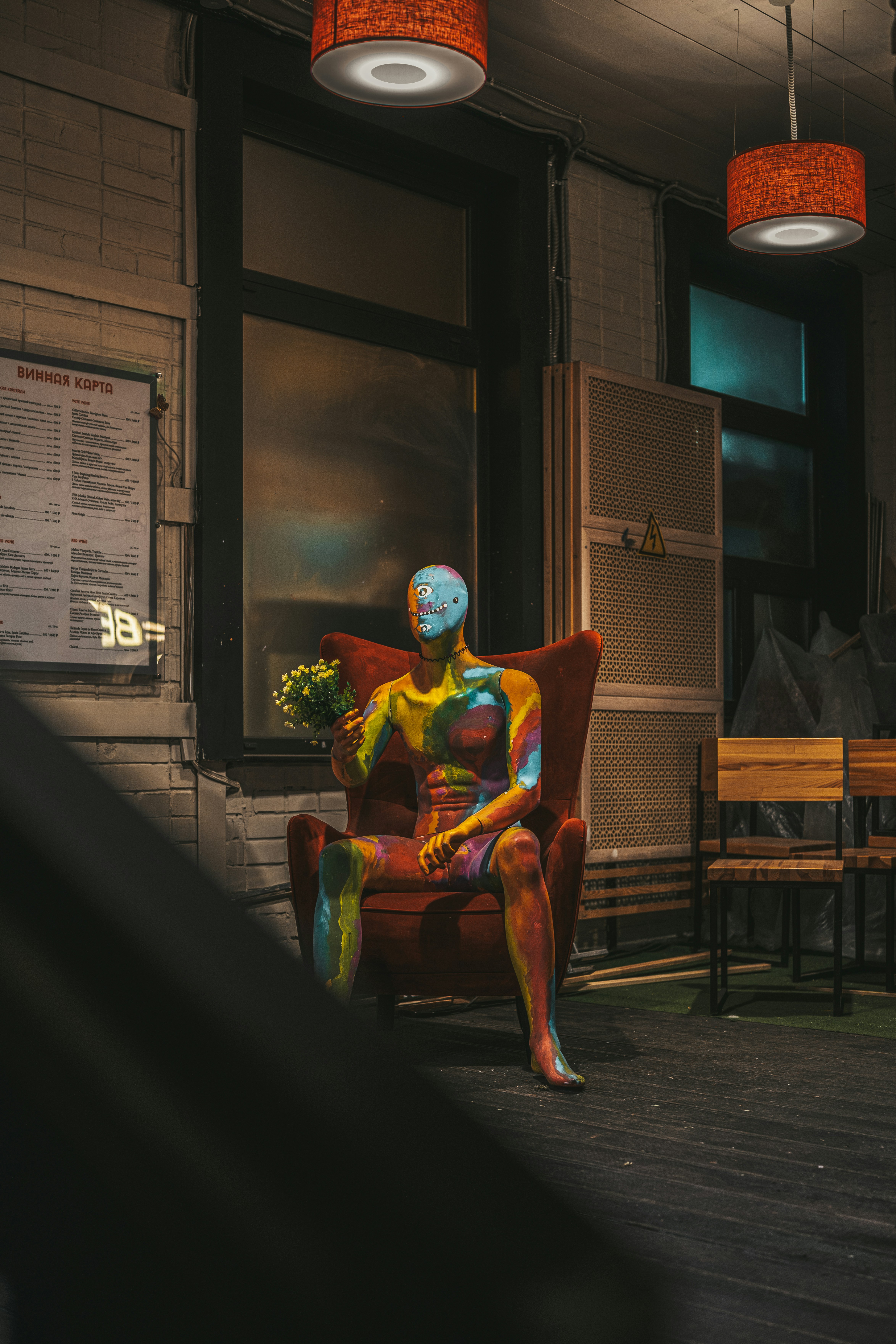 Chromatic Muse in a Red Armchair: Bouquet and Neon in an Industrial Room
