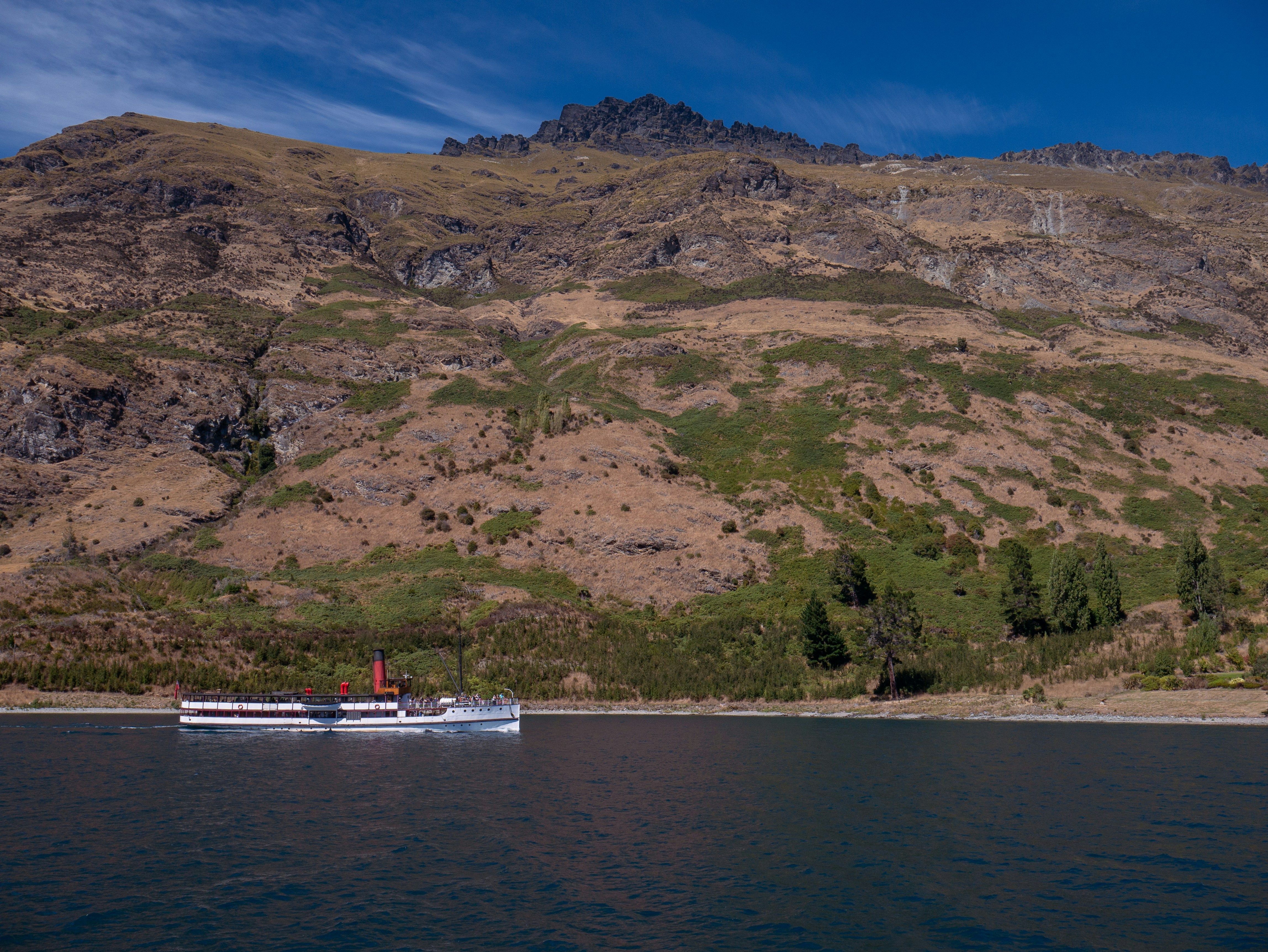 Red-Funnel Steamer Traces a Quiet Line Across Desert River