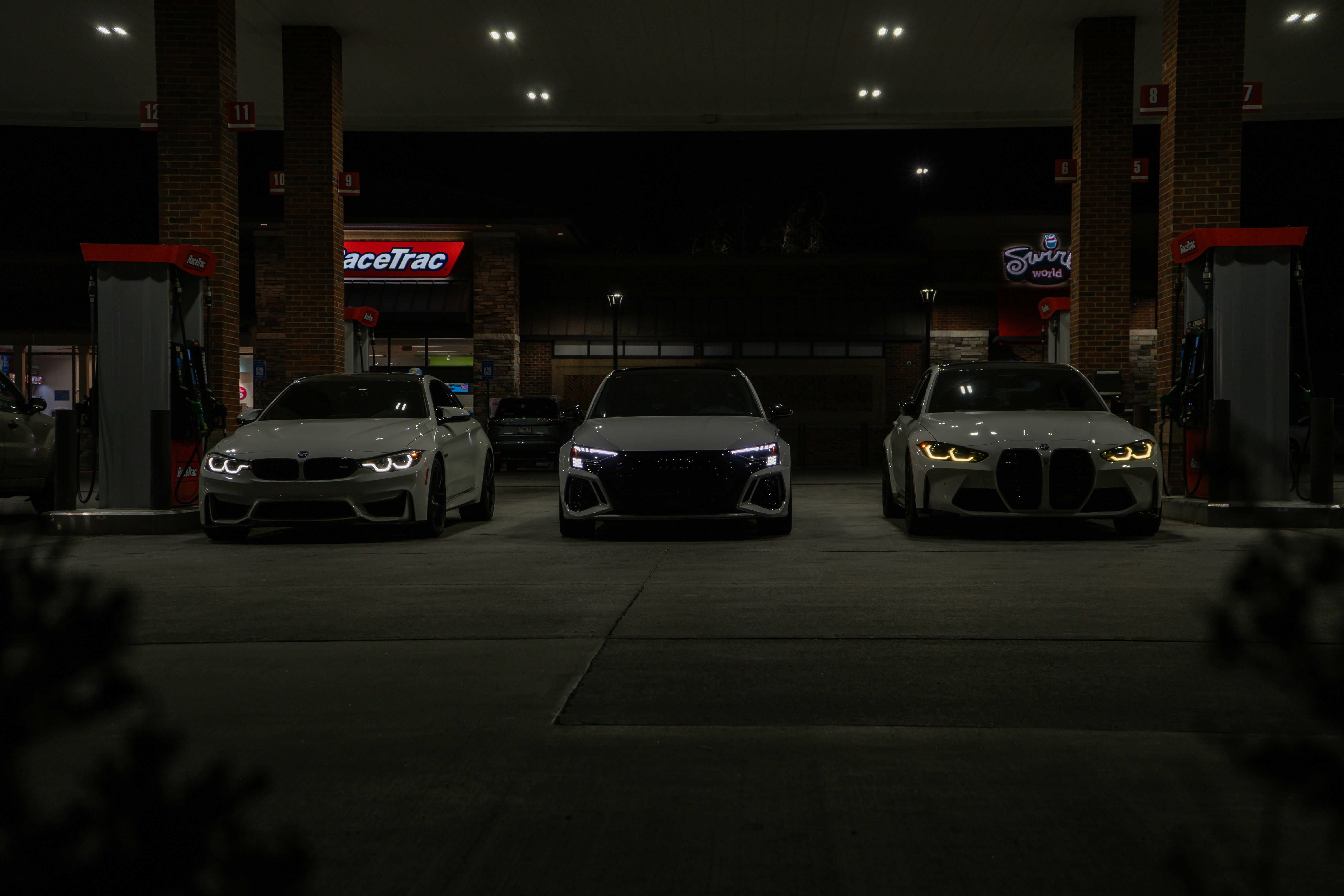 Three cars are parked at a gas station at night. photo – Free Car Image ...