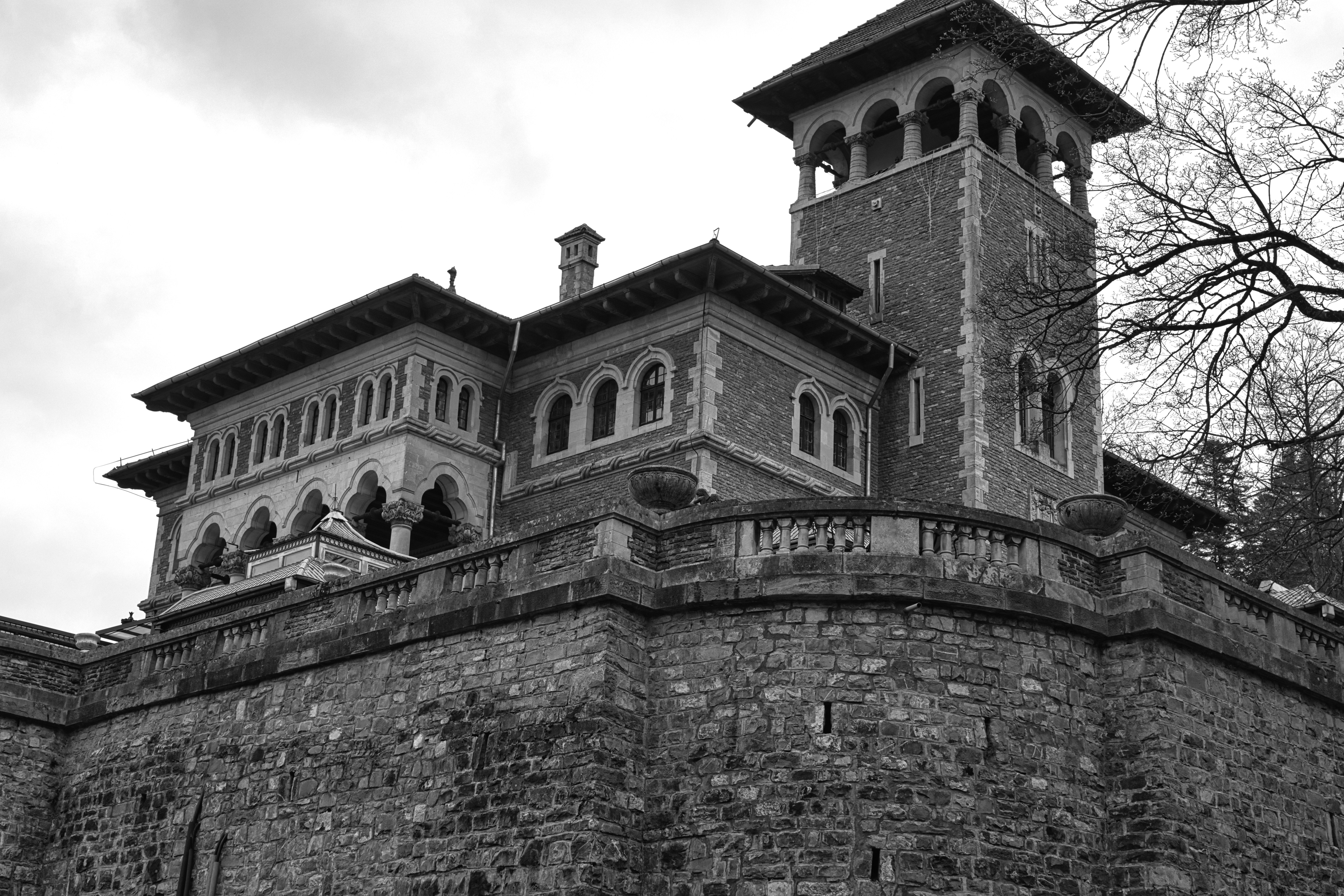 A majestic castle stands atop a sturdy stone wall. photo – Free ...