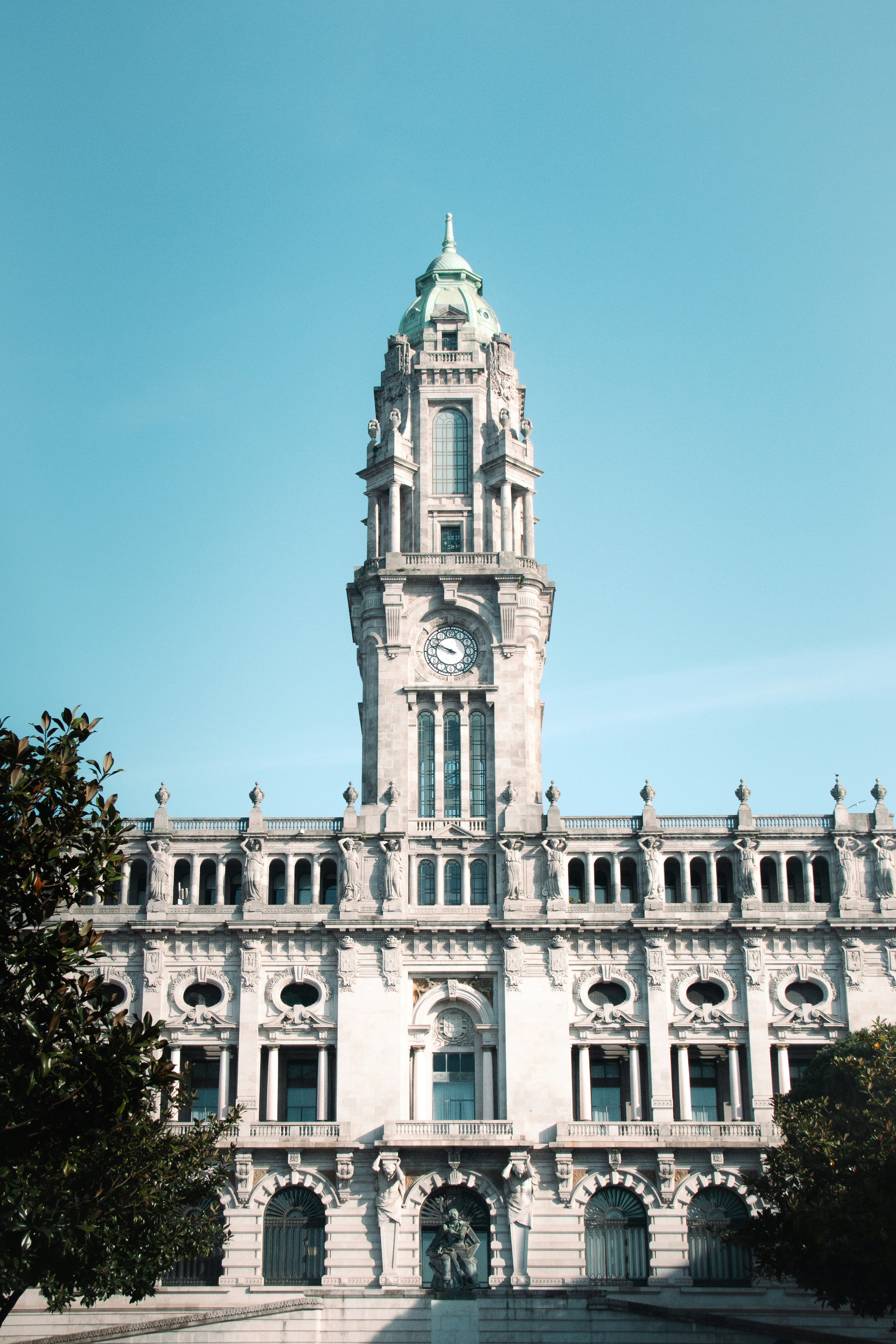 Clocktower Crowned by a Cerulean Sky over a Neoclassical Facade